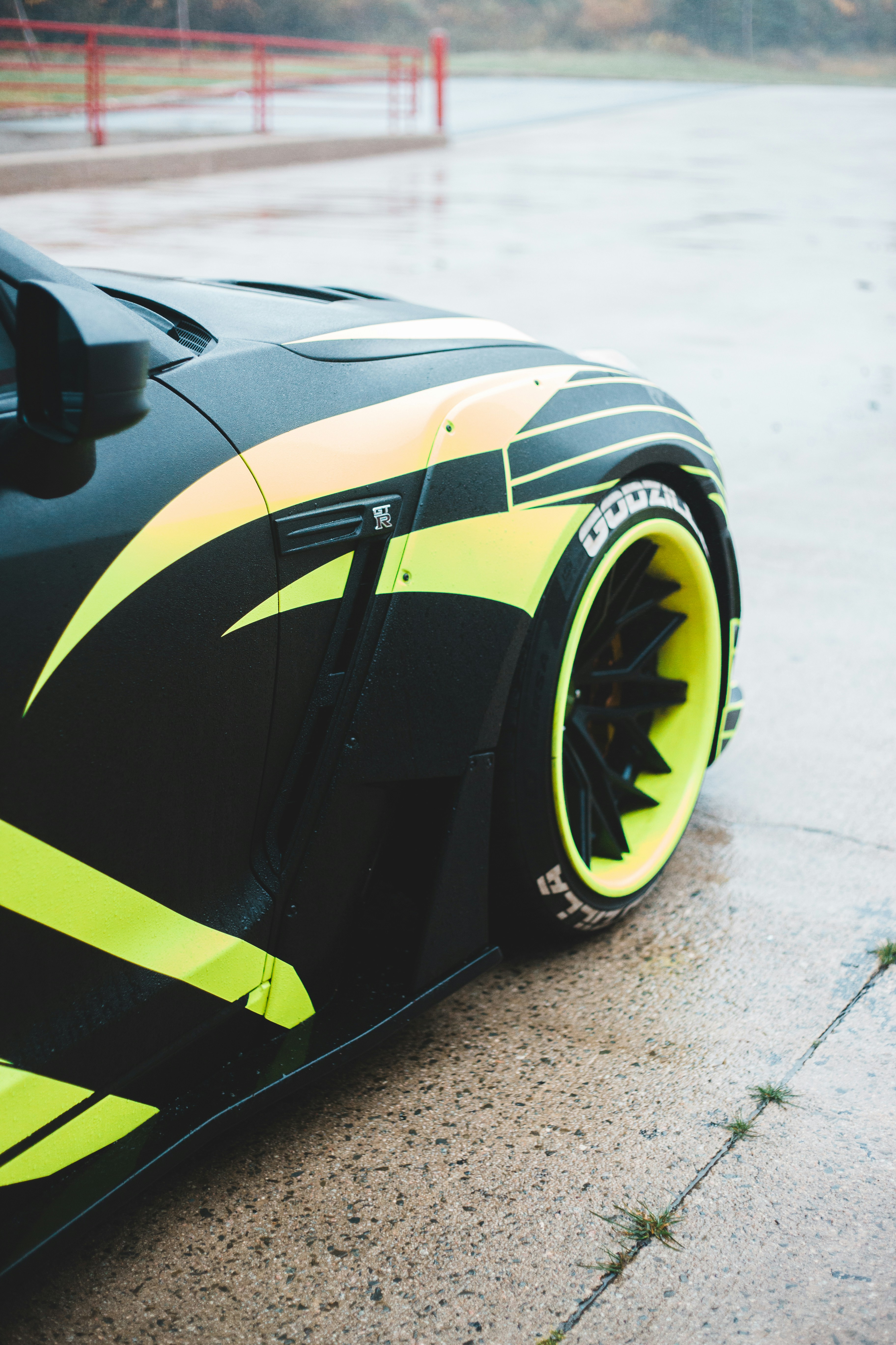 Neon-Lined Velocity: Close-Up on a Black Race Car with Lime Accents