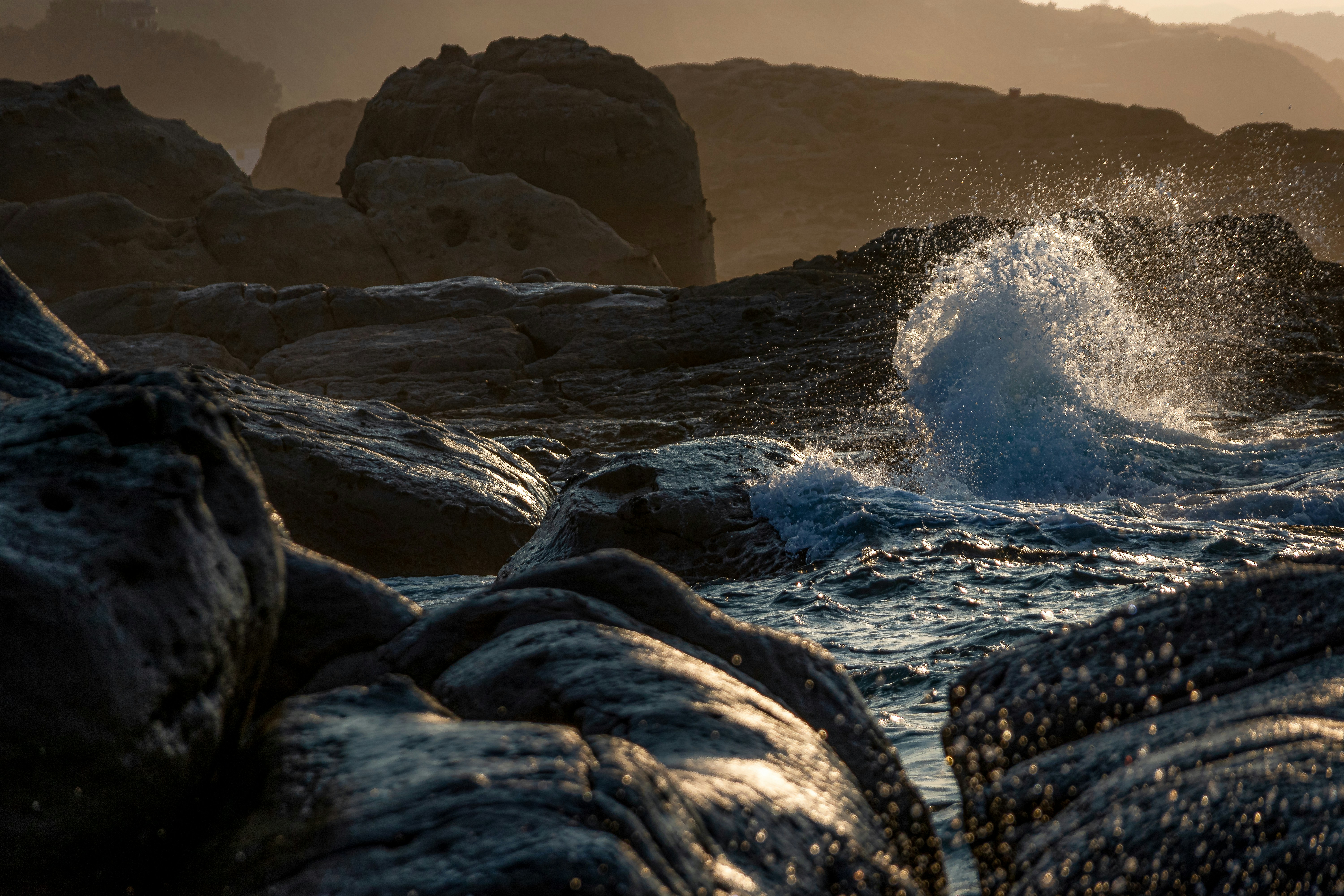 Twilight Crest: Spray Against Weathered Basalt