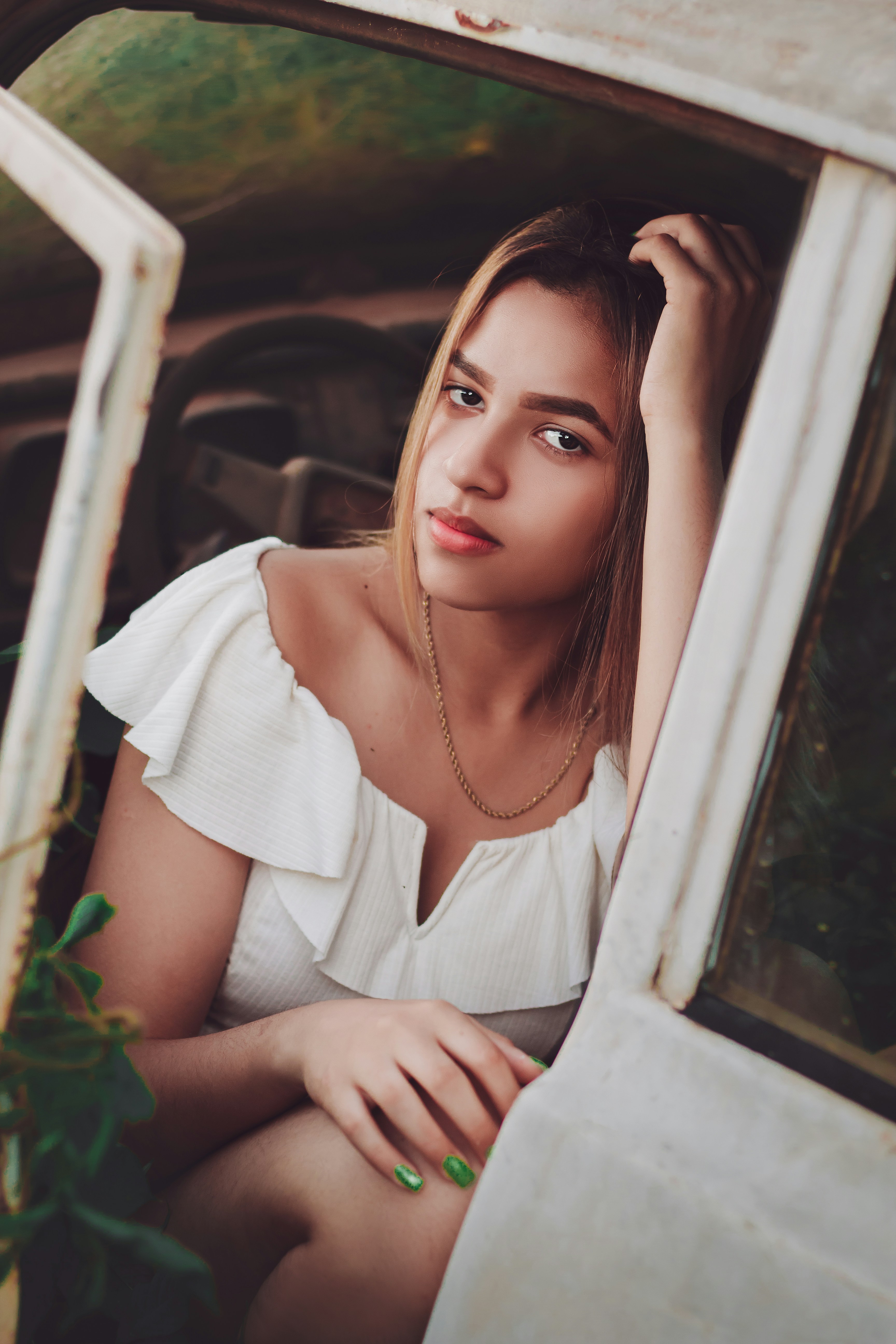 Windowed Gaze: Portrait in a Weathered Car