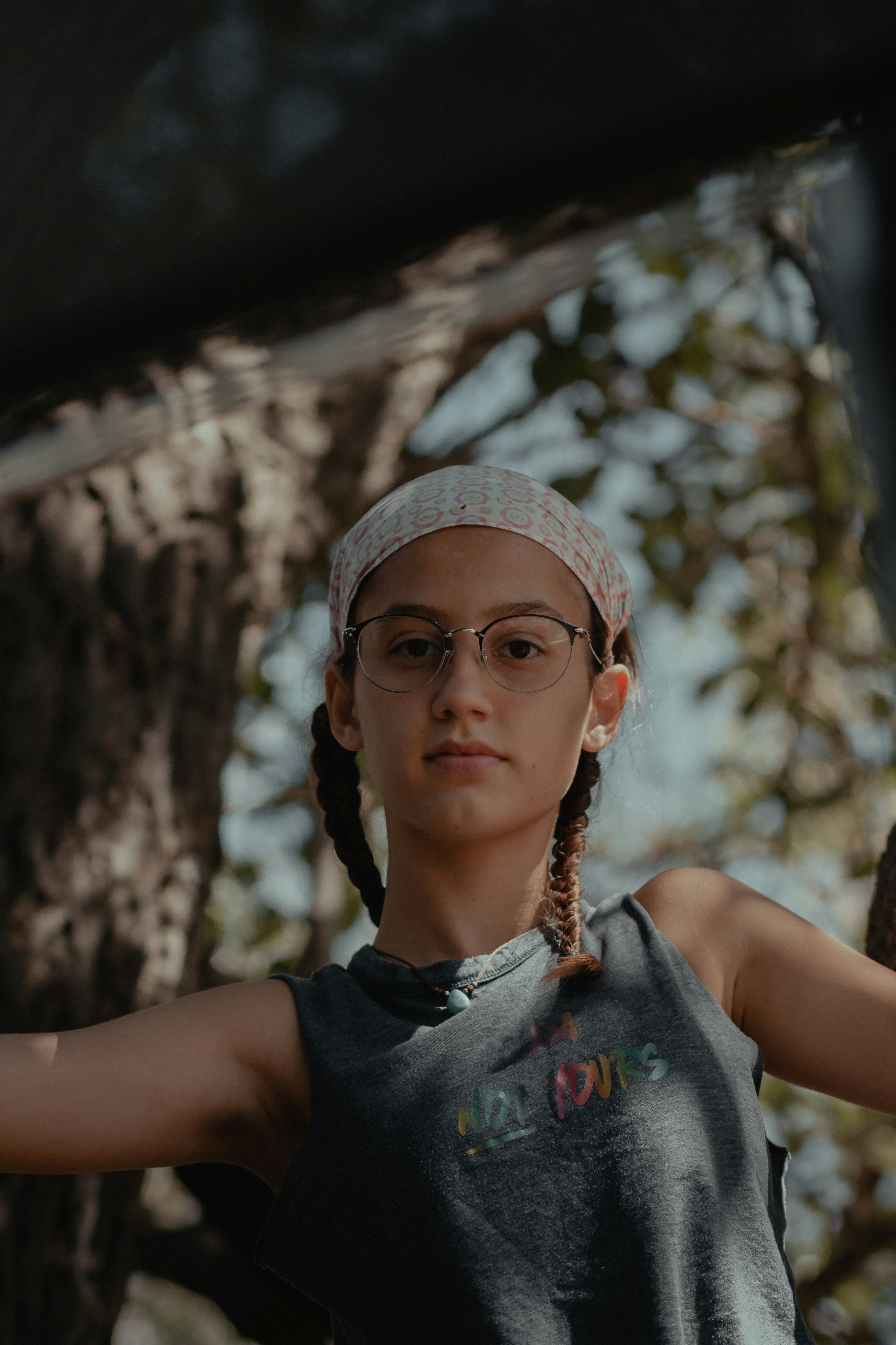 Braids in the Shade: A Quiet Portrait Beneath Forest Light