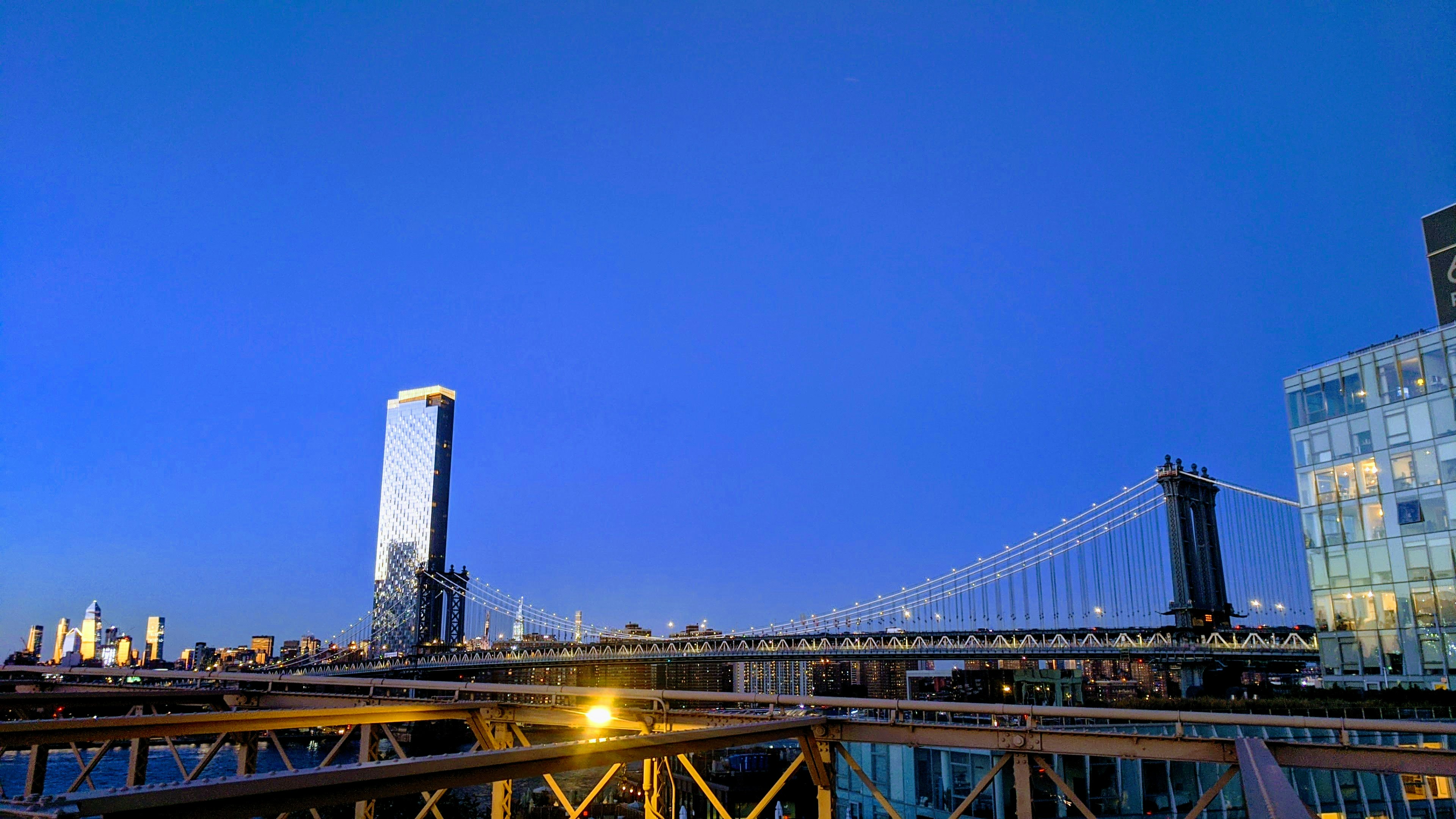 Blue Hour Symphony: Lamp in the Foreground, Bridge Towers, and a Glass City Skyline