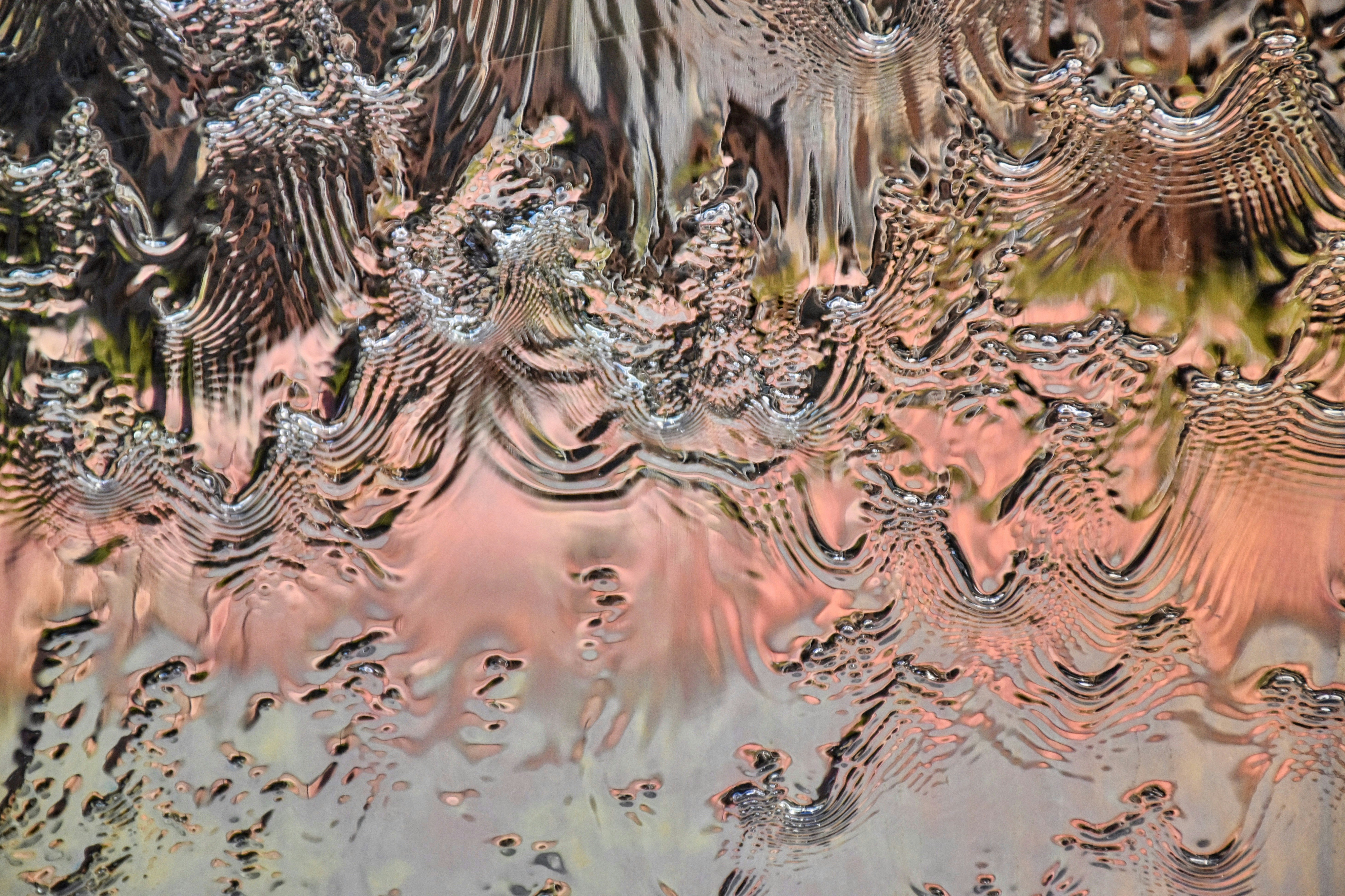 Abstract patterns formed by water droplets creating a mesmerizing interplay of light and color.