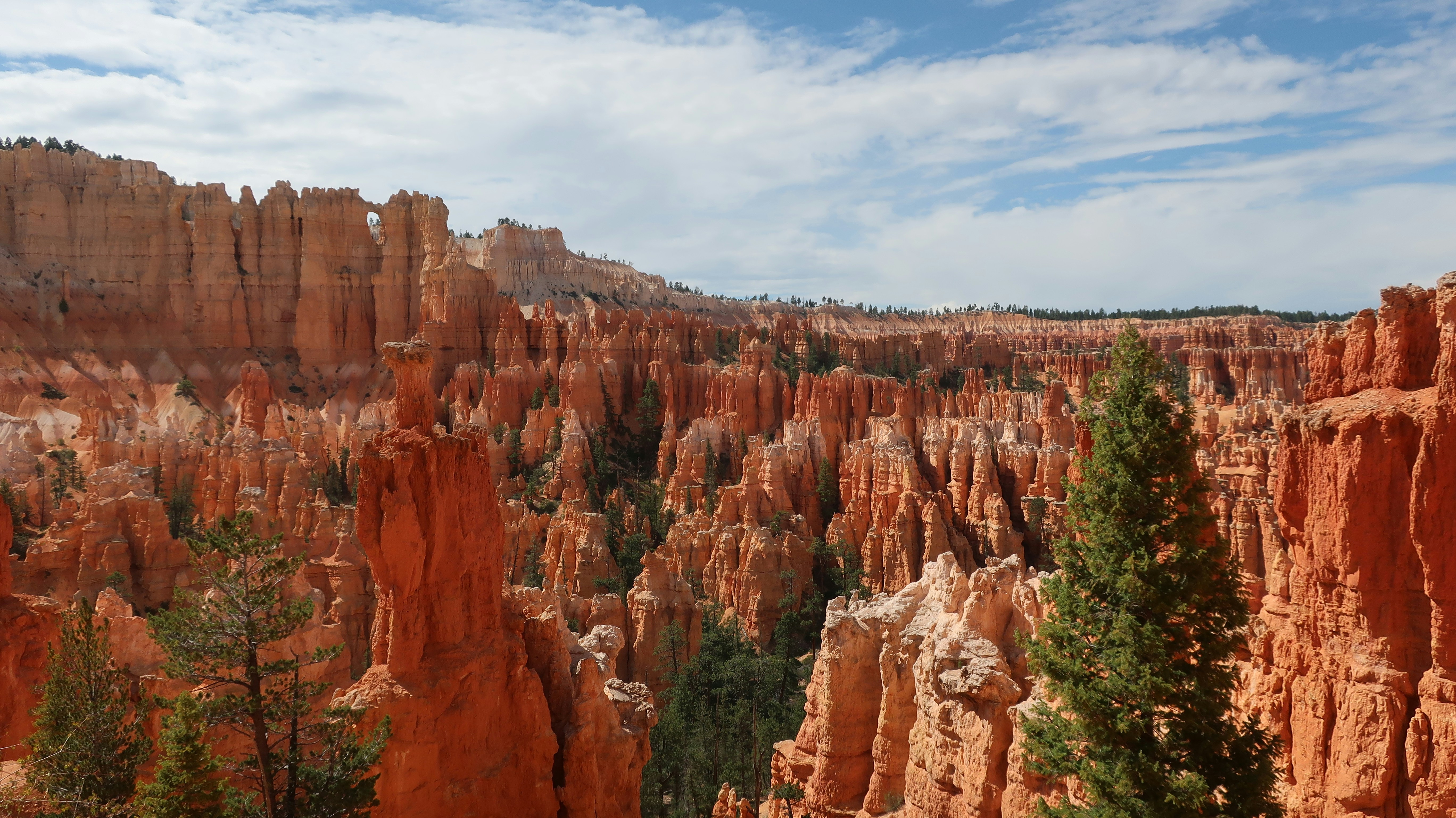 Hoodoos and spires rise dramatically under a vibrant sky at Bryce Canyon.