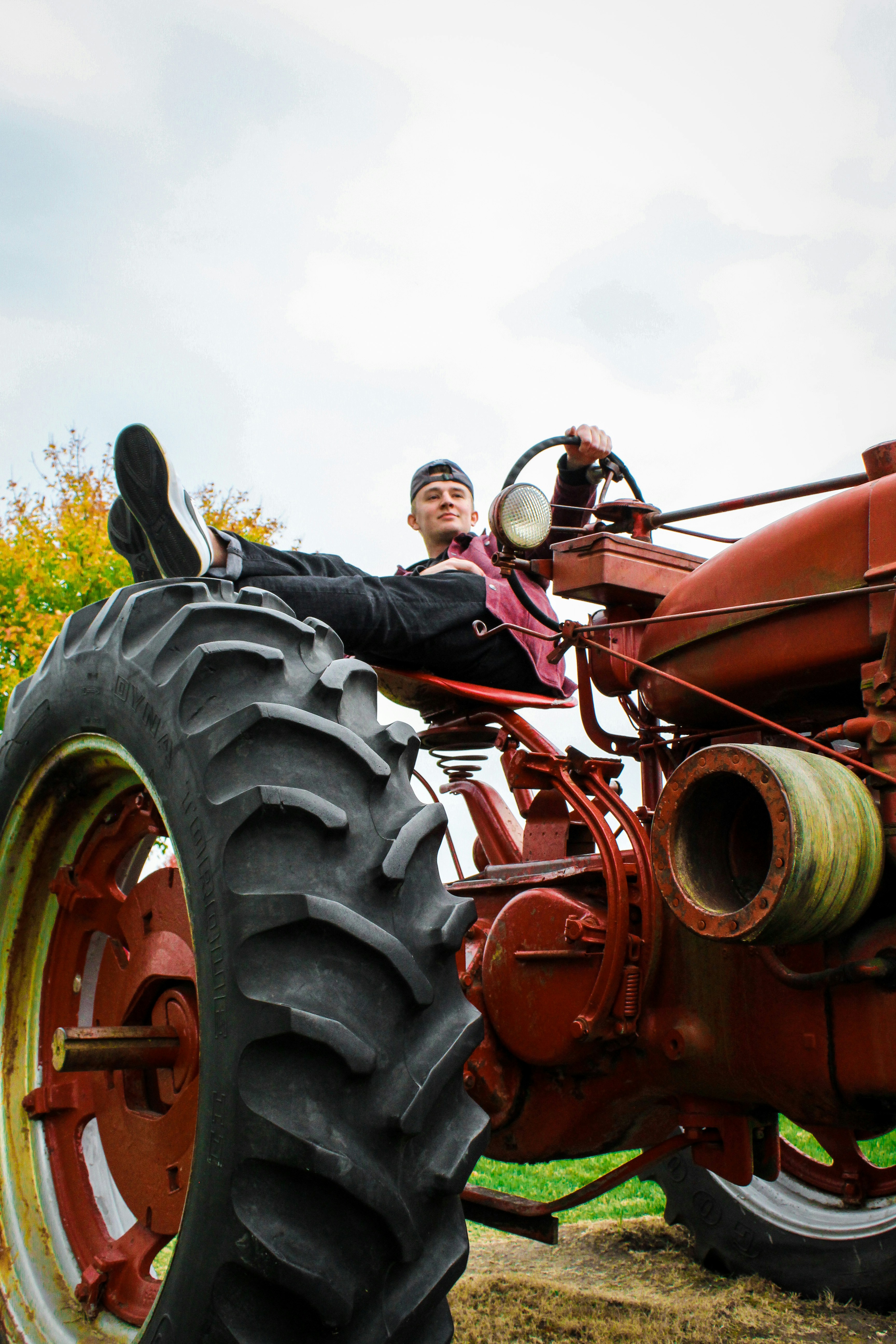 Man in black jacket riding red tractor photo – Free All seasons orchard ...