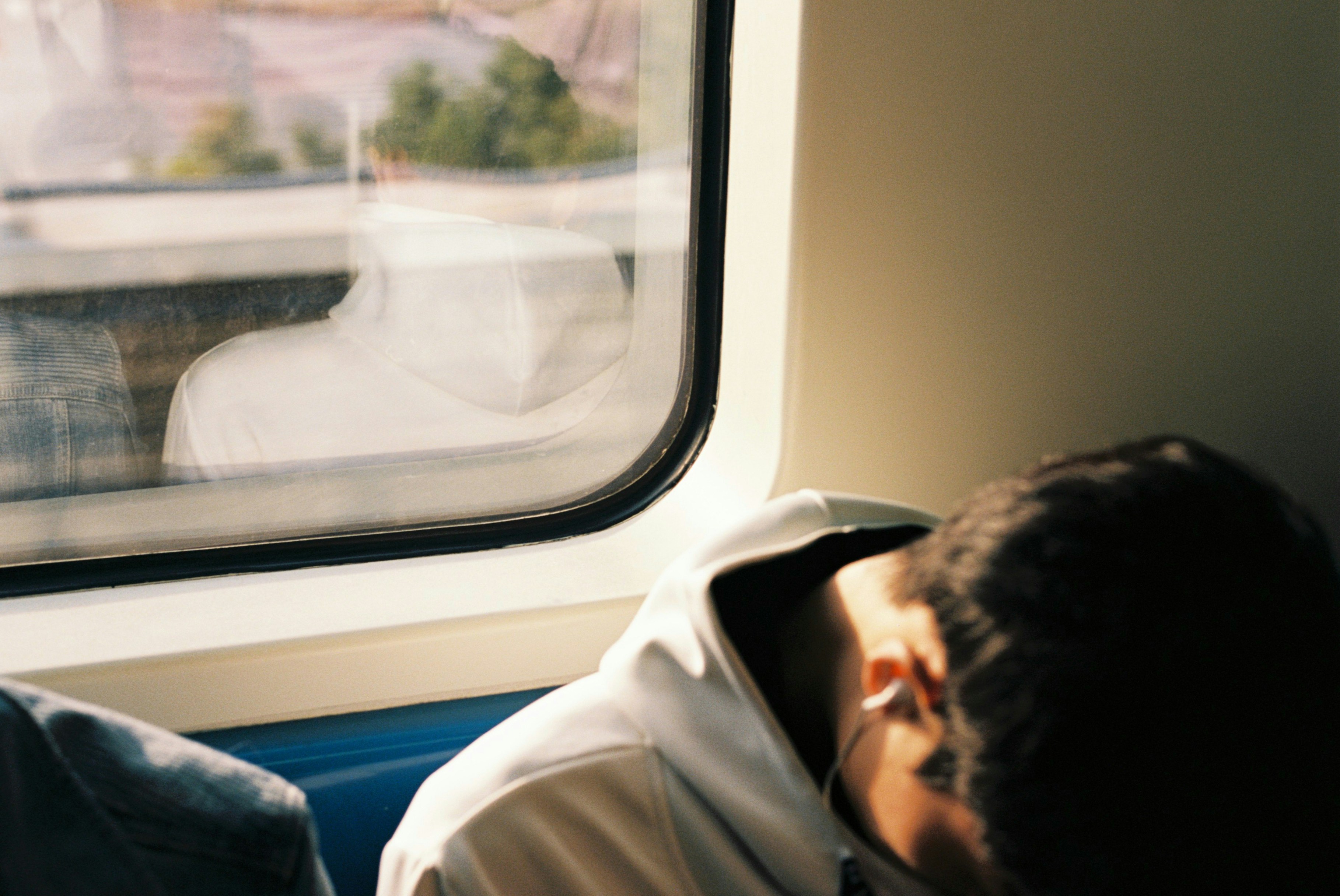 Hooded Quiet by the Window on a Moving Bus