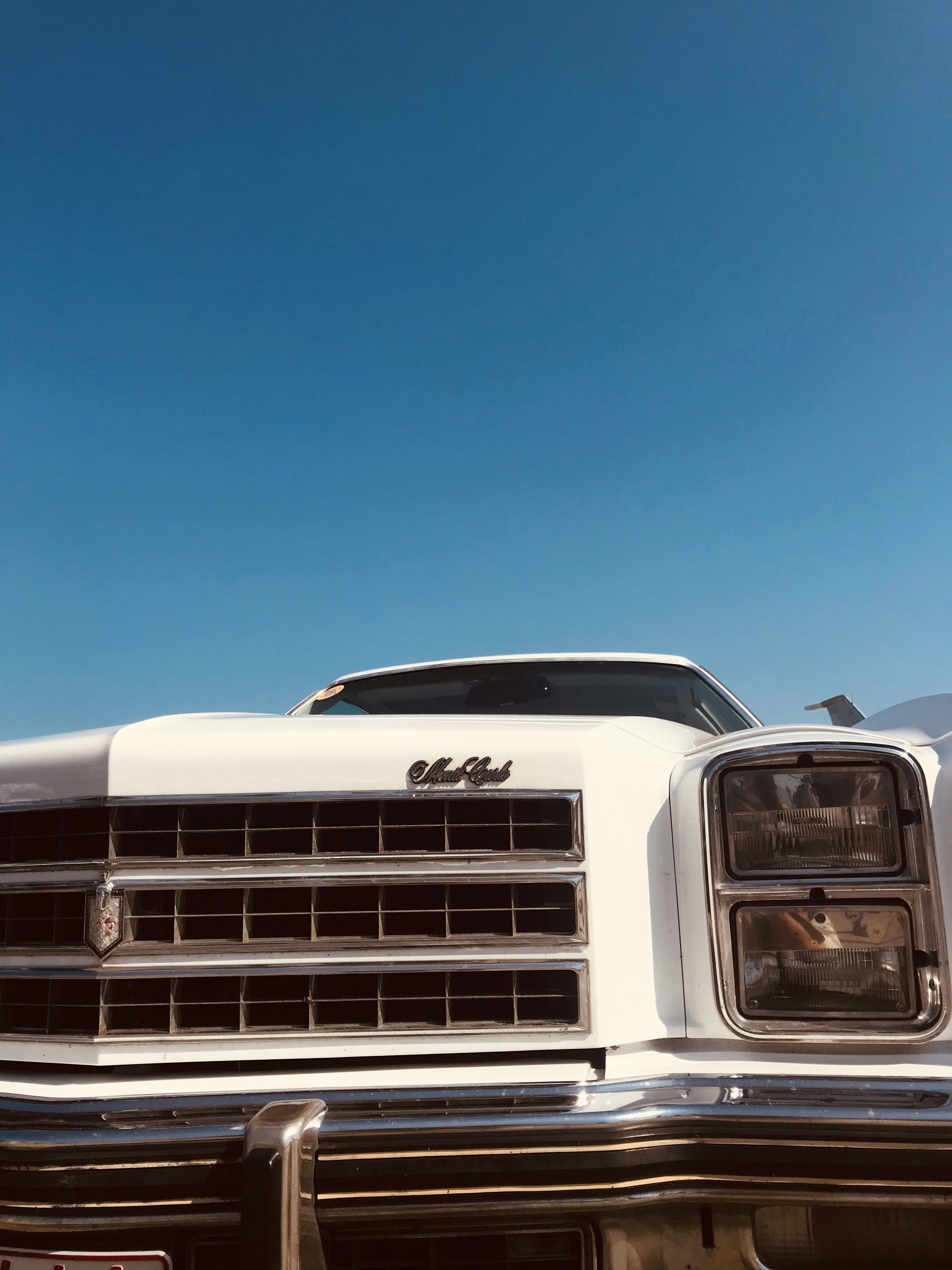 GMC Chrome Grille Portrait: White Pickup Against a Cerulean Sky