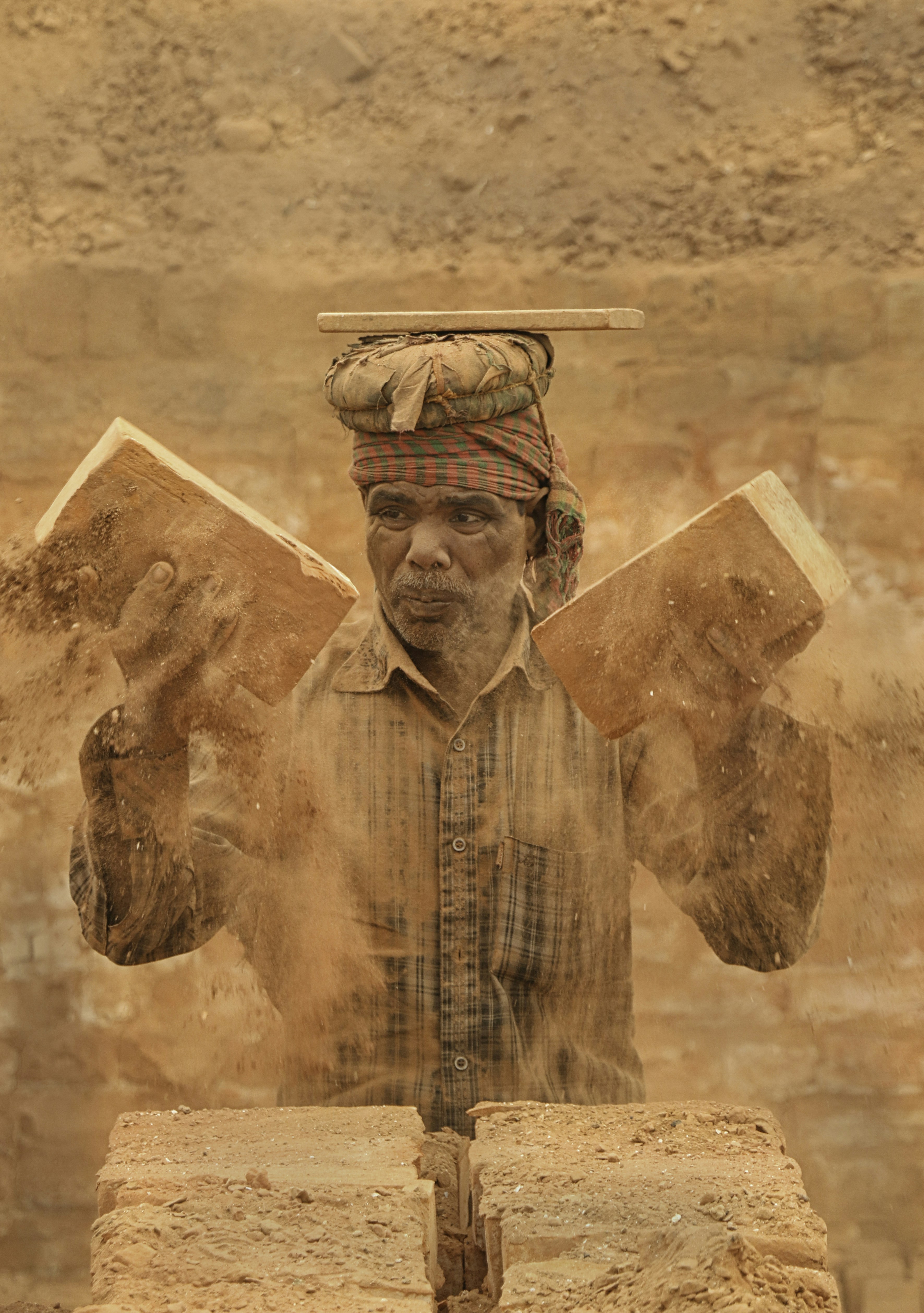 Balancing Bricks in the Dust: A Moment of Focus Under Construction