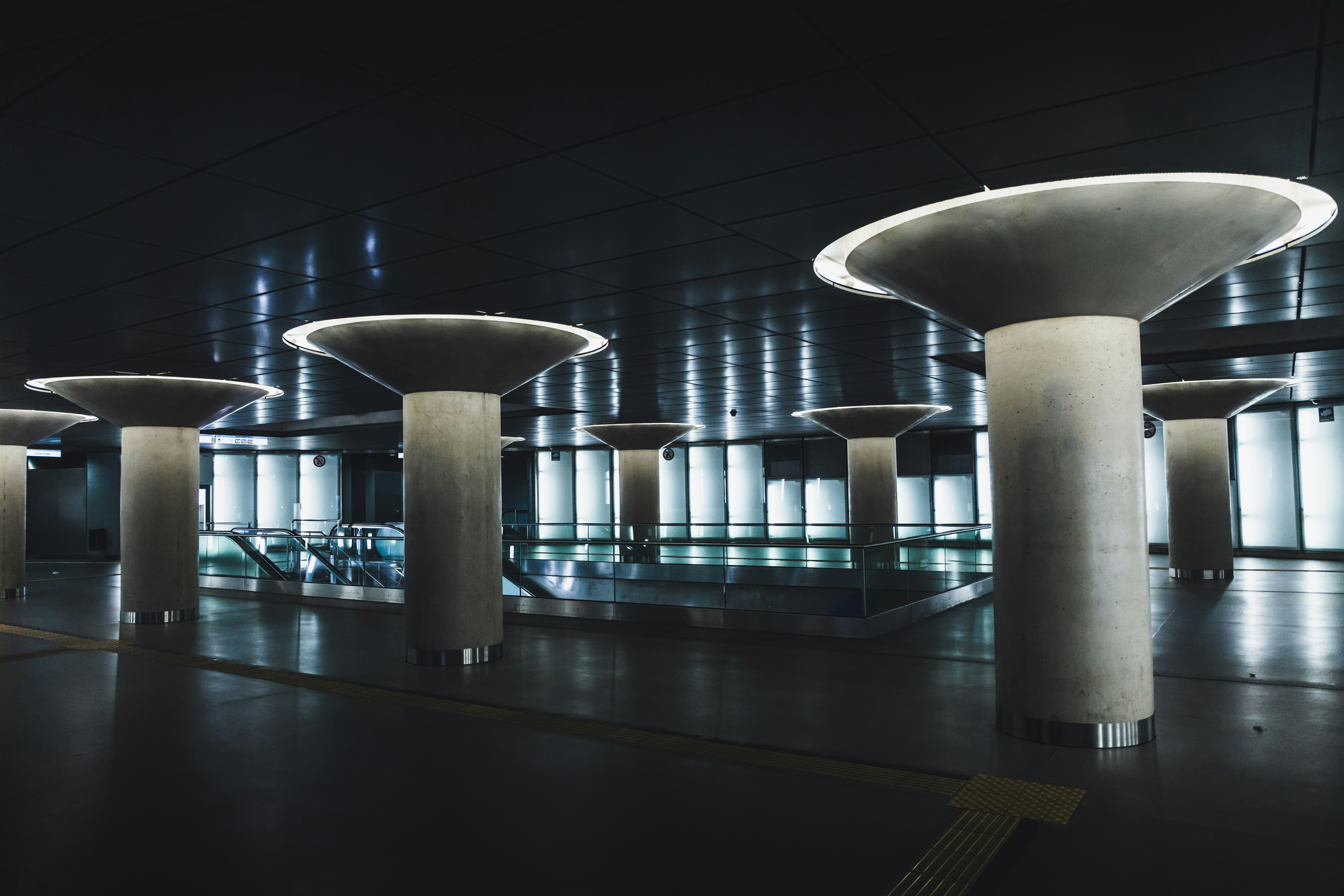 Haloed Pillars Over a Quiet Underground Atrium
