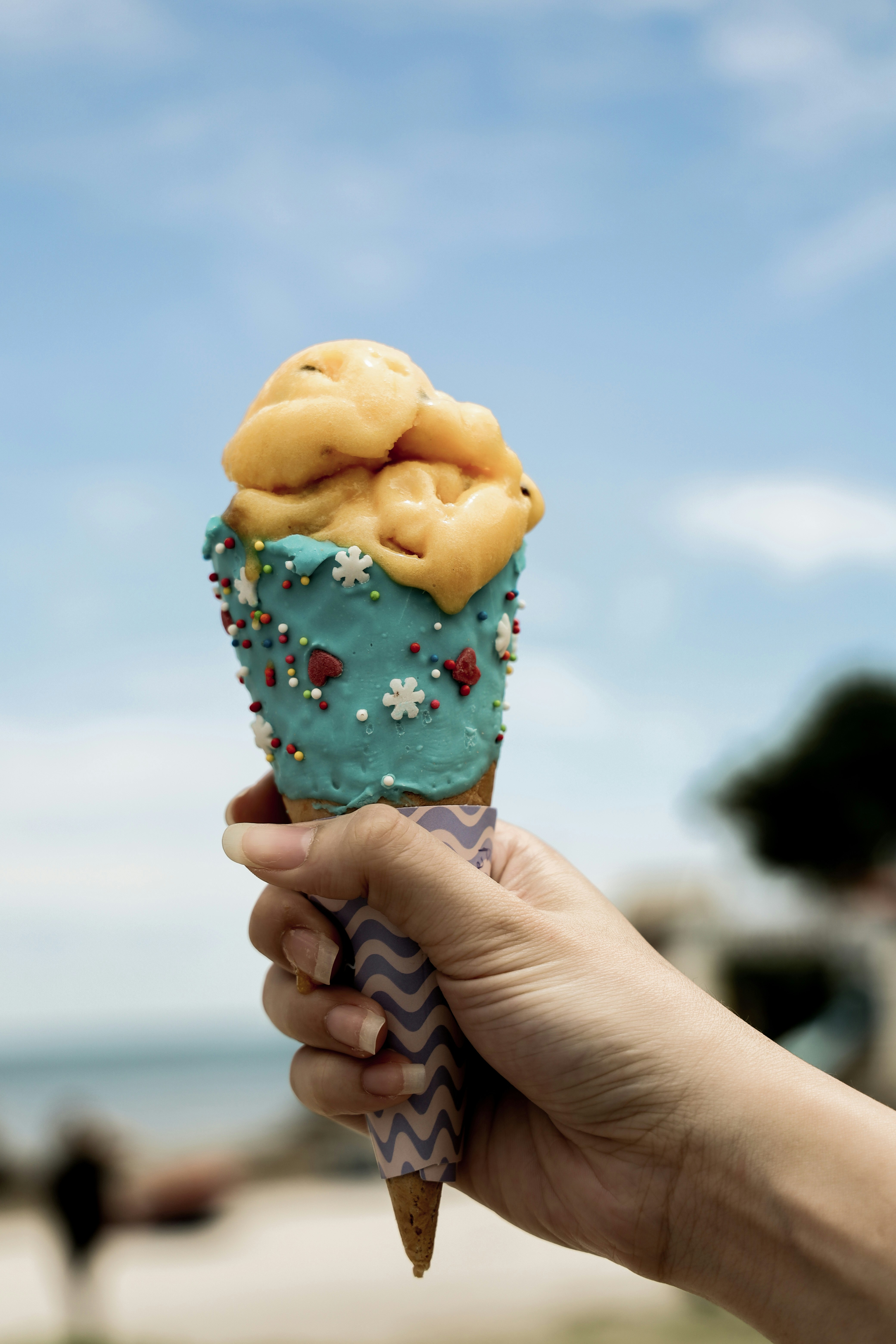 Azure Cone on a Beach Day: Candy-Flower Ice Cream Against a Seaside Sky