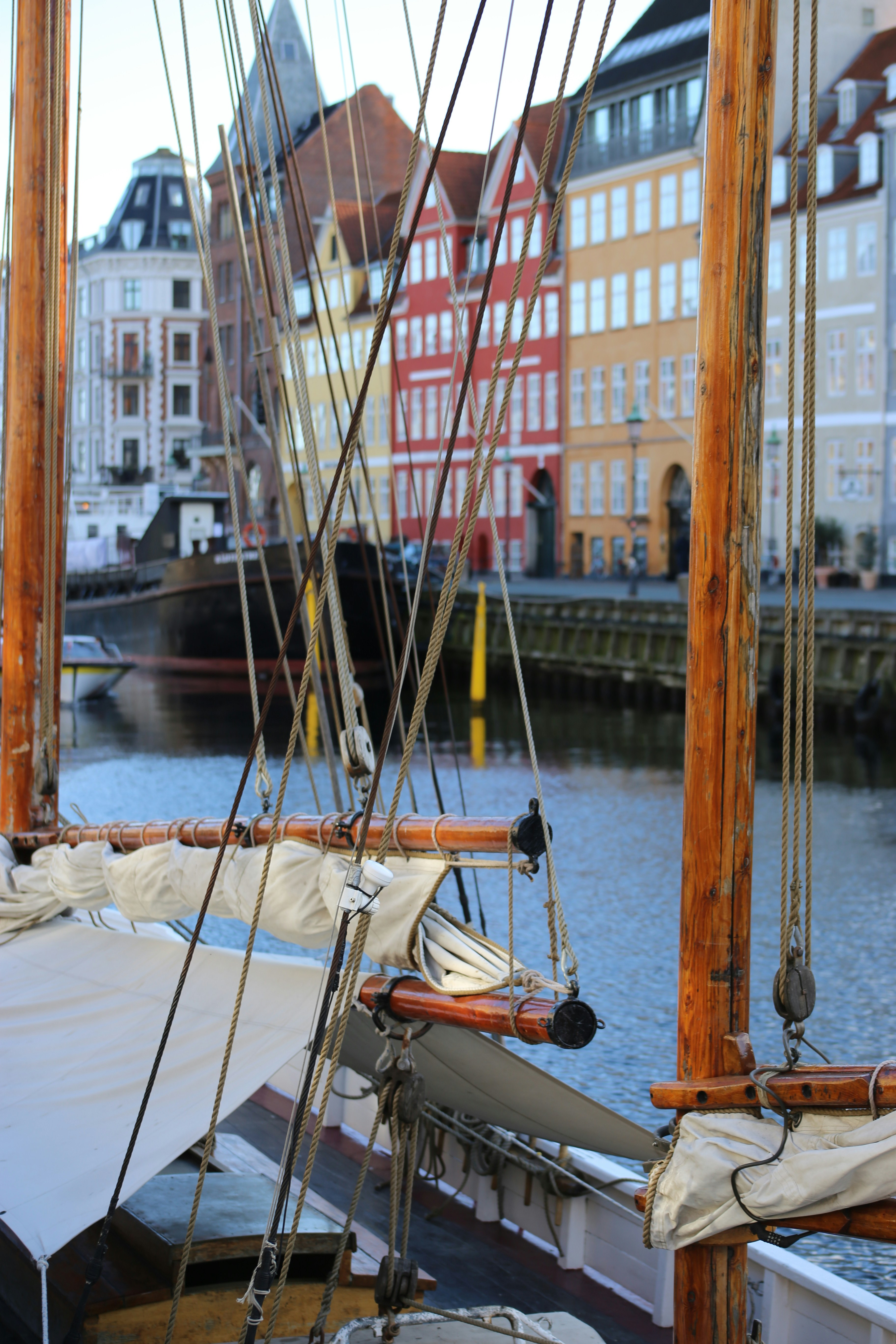 Masted History: A Sailboat Portrait against a Row of Colorful Townhouses