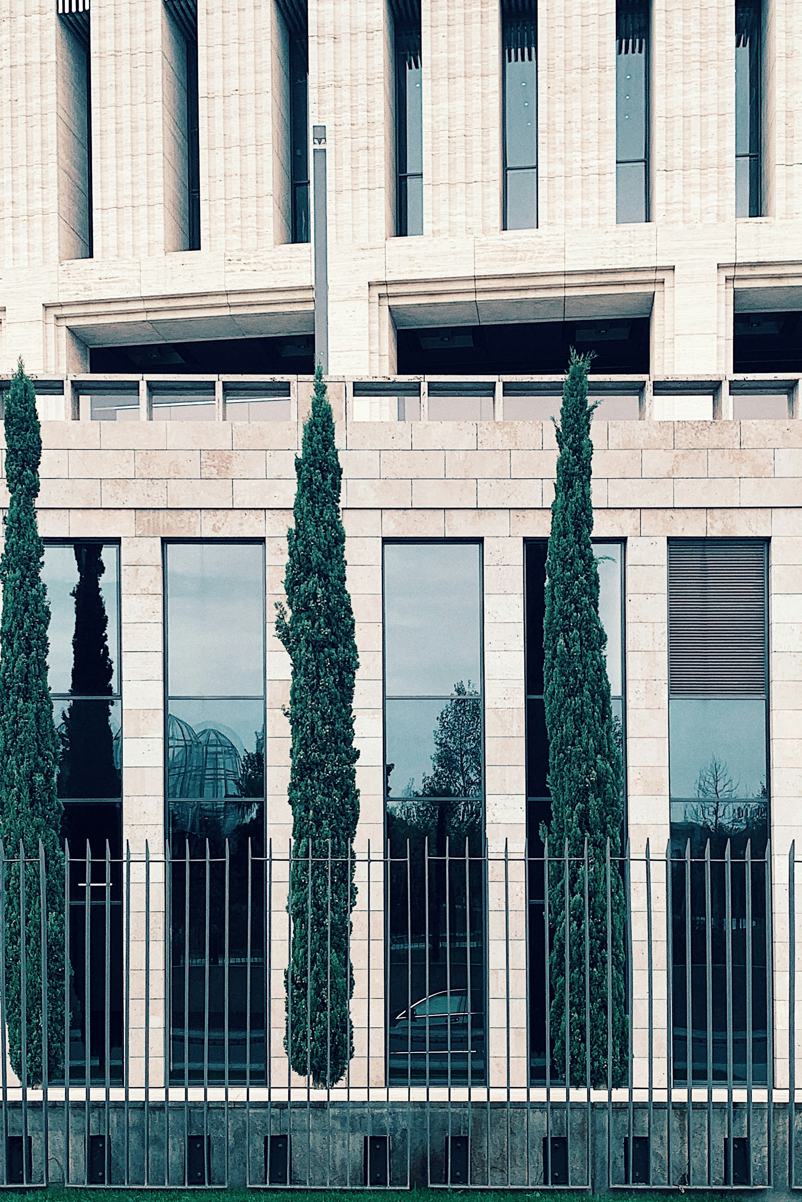 Cypress Sentries Framing a Geometric Facade
