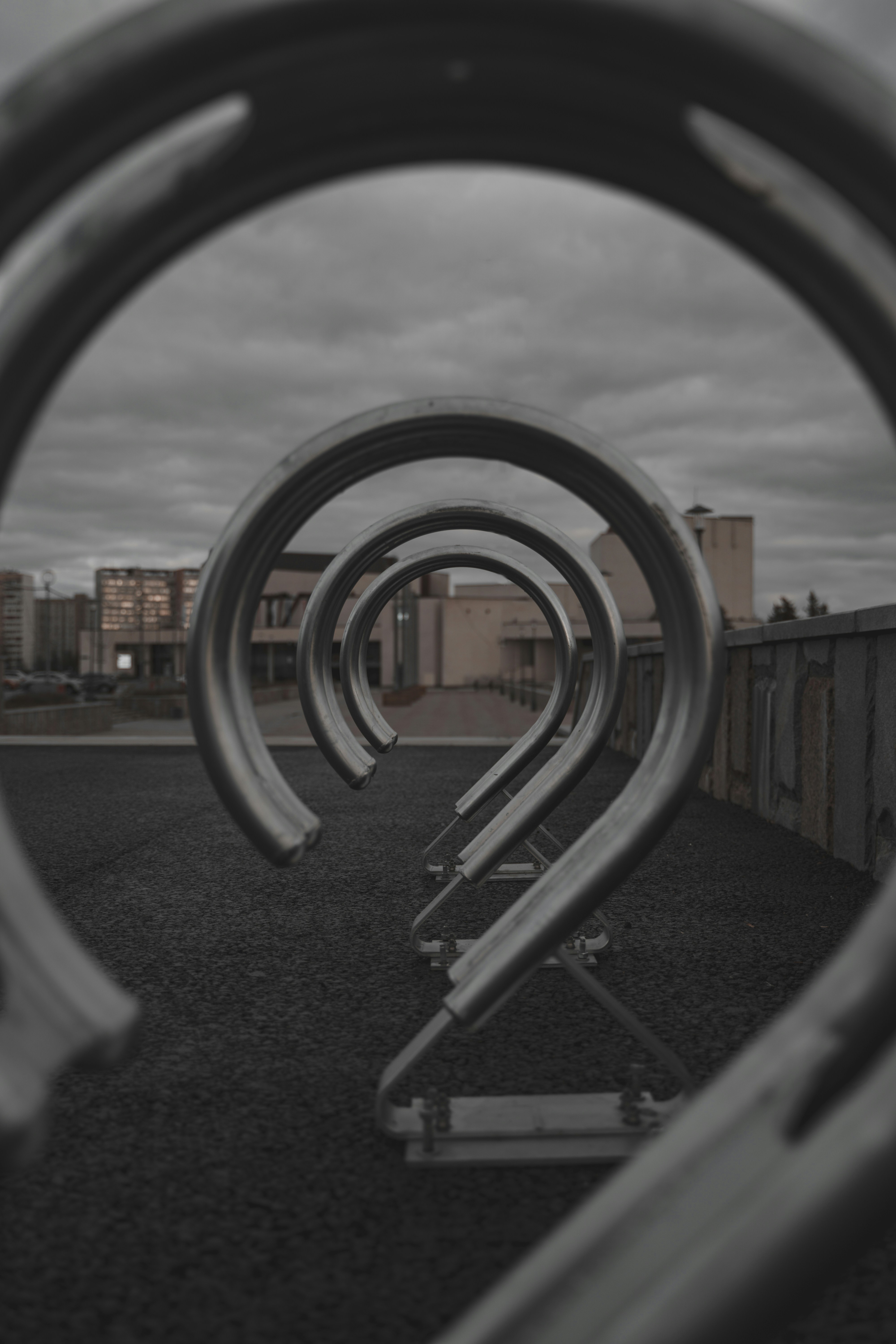 Circular Path: A Rooftop Corridor of Metal Hoops Receding into Dusk
