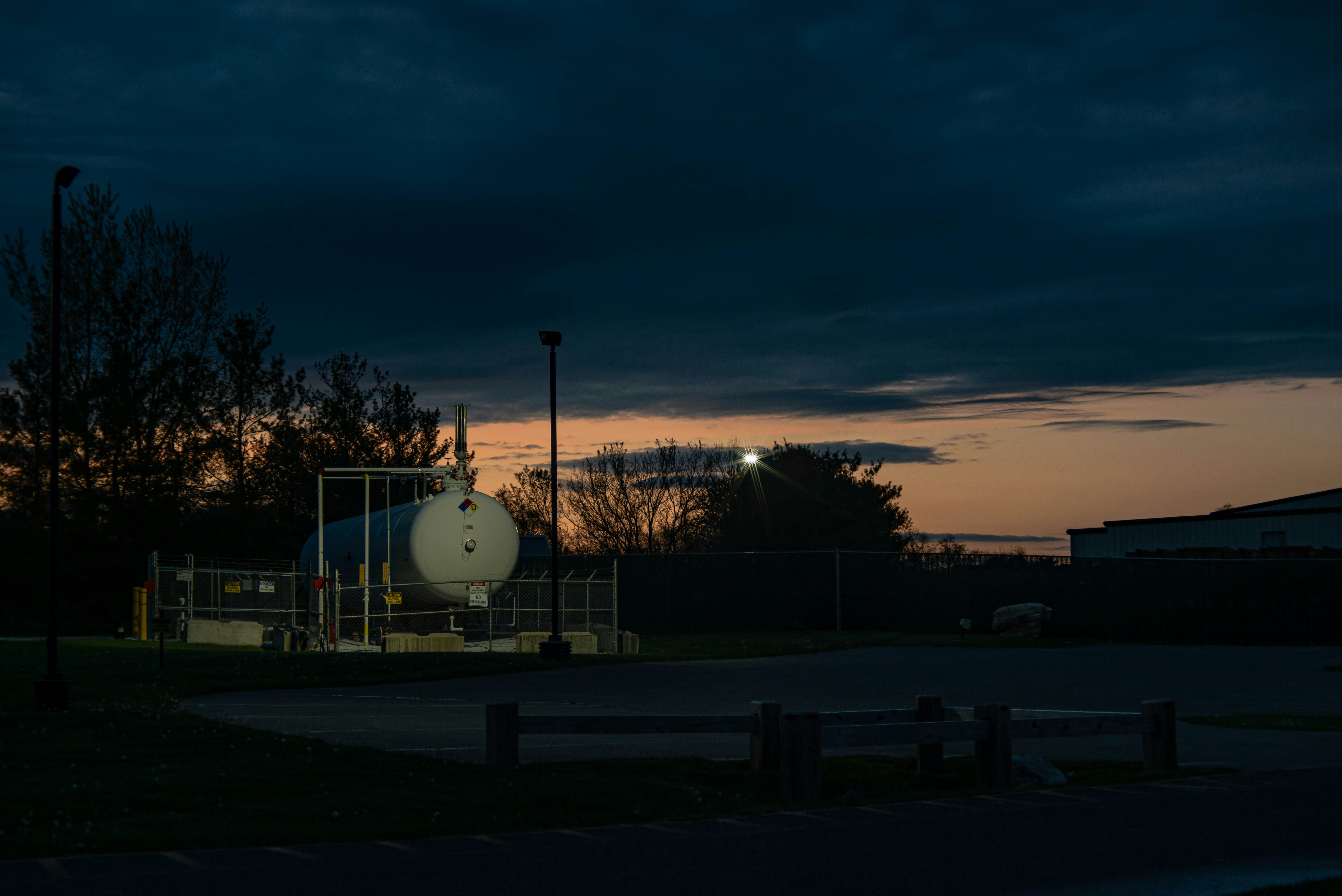 Blue Hour Sentinel: The White Tank in a Quiet Industrial Yard