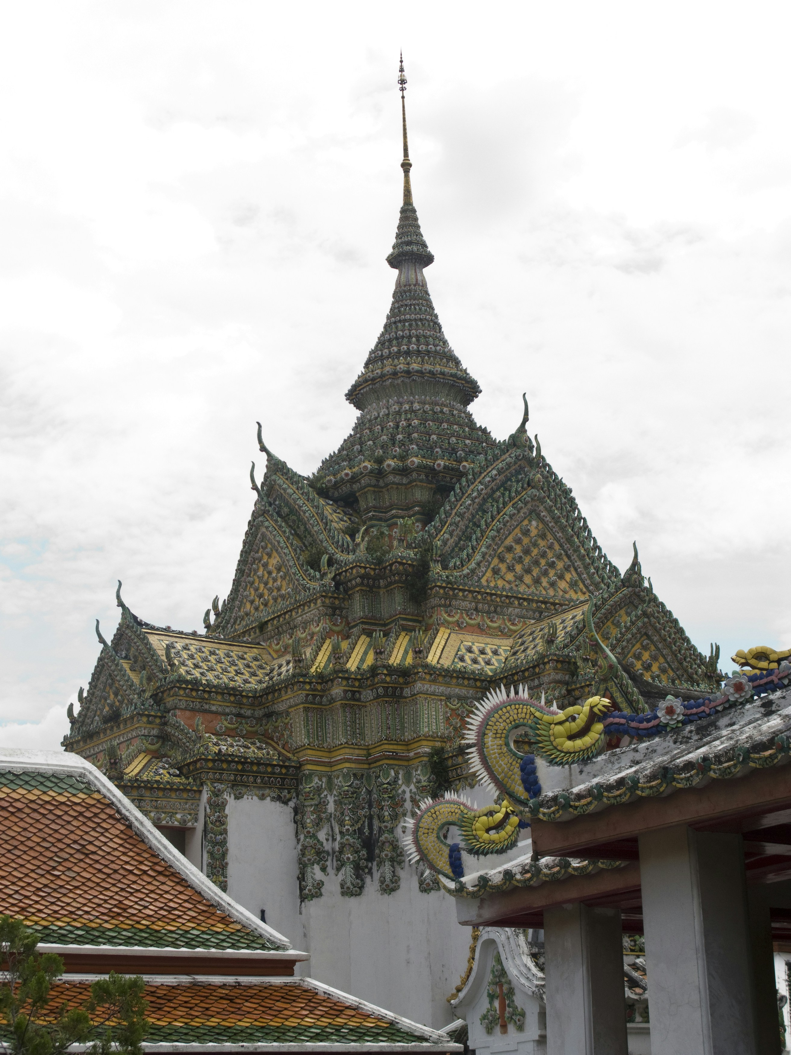 Intricate temple spire adorned with detailed carvings and vibrant colors, showcasing the beauty of traditional Thai design.