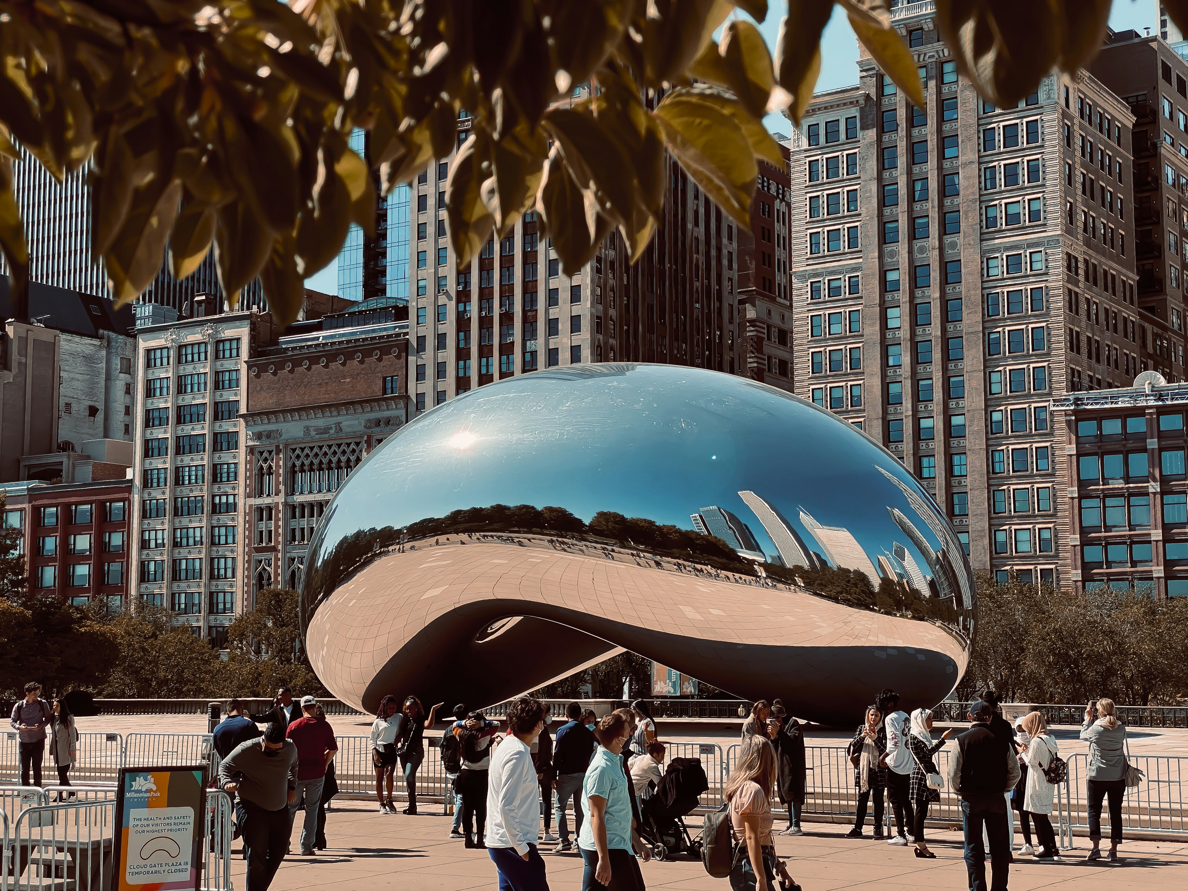 people walking on street near cloud gate during daytime