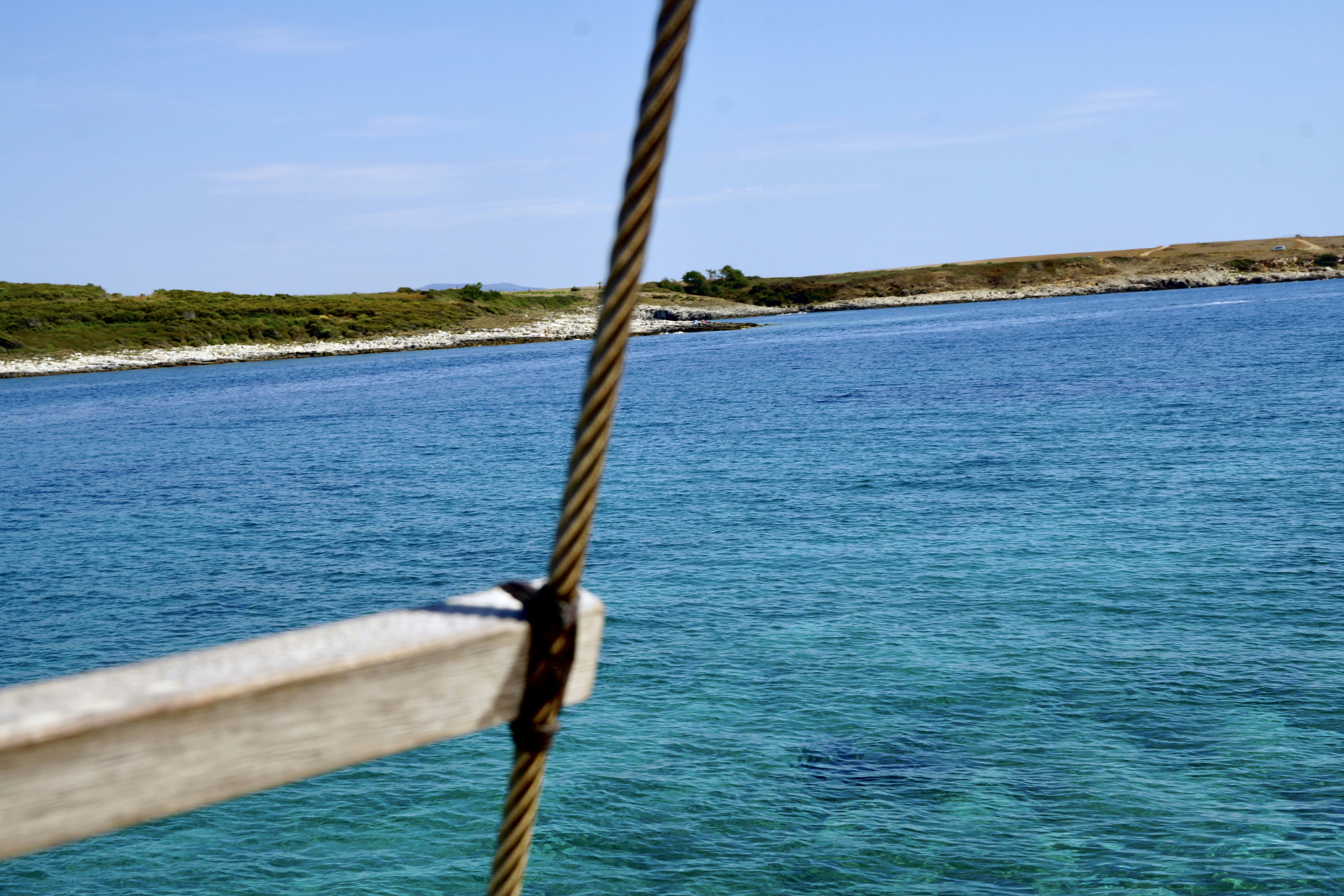 Rope and Horizon: A Seafront View Framed by Sailing Rigging