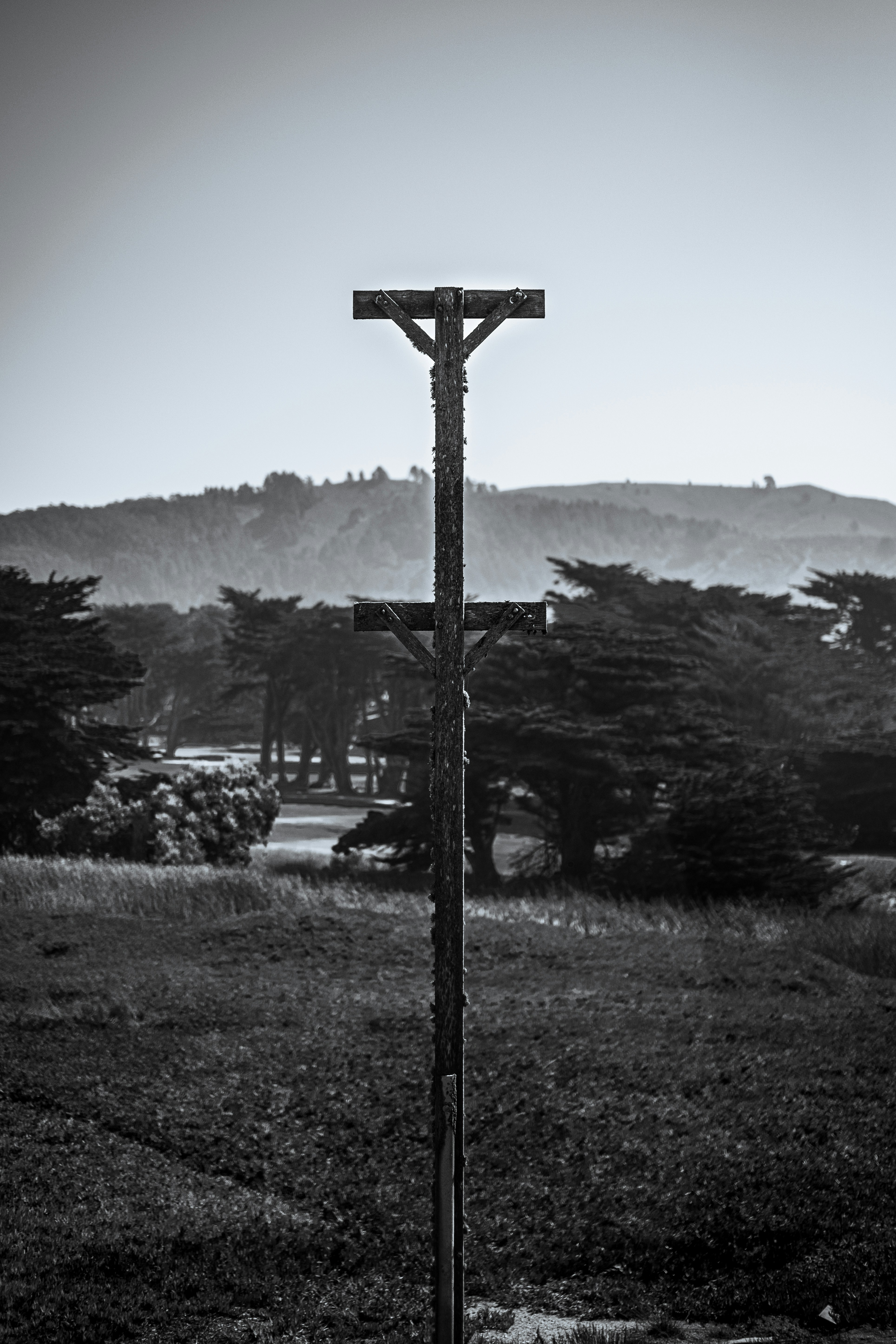 Crossing Silence: A Weathered Post in a Graveled Field