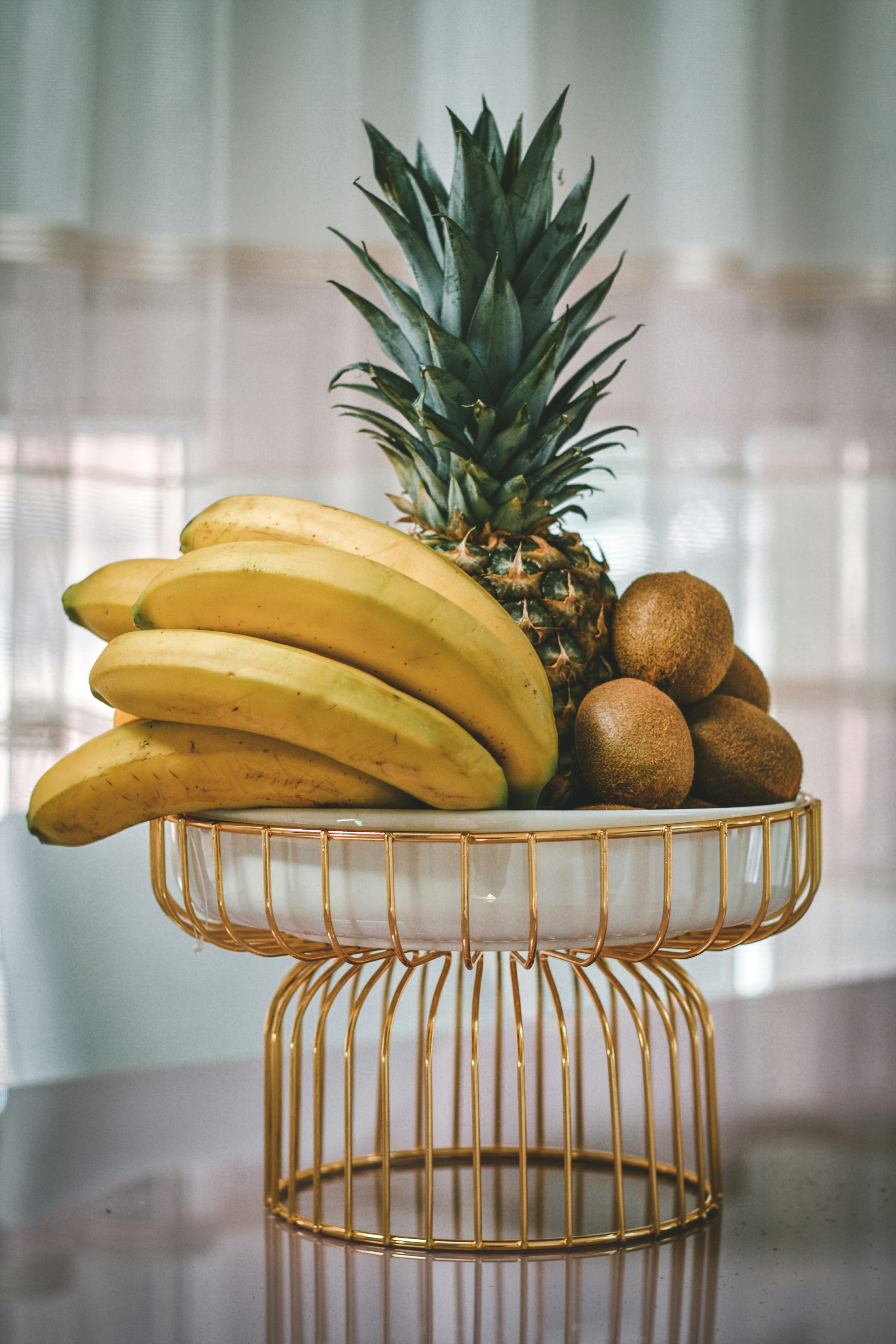 Pineapple Crown and Banana Arc on a Golden Wire Pedestal