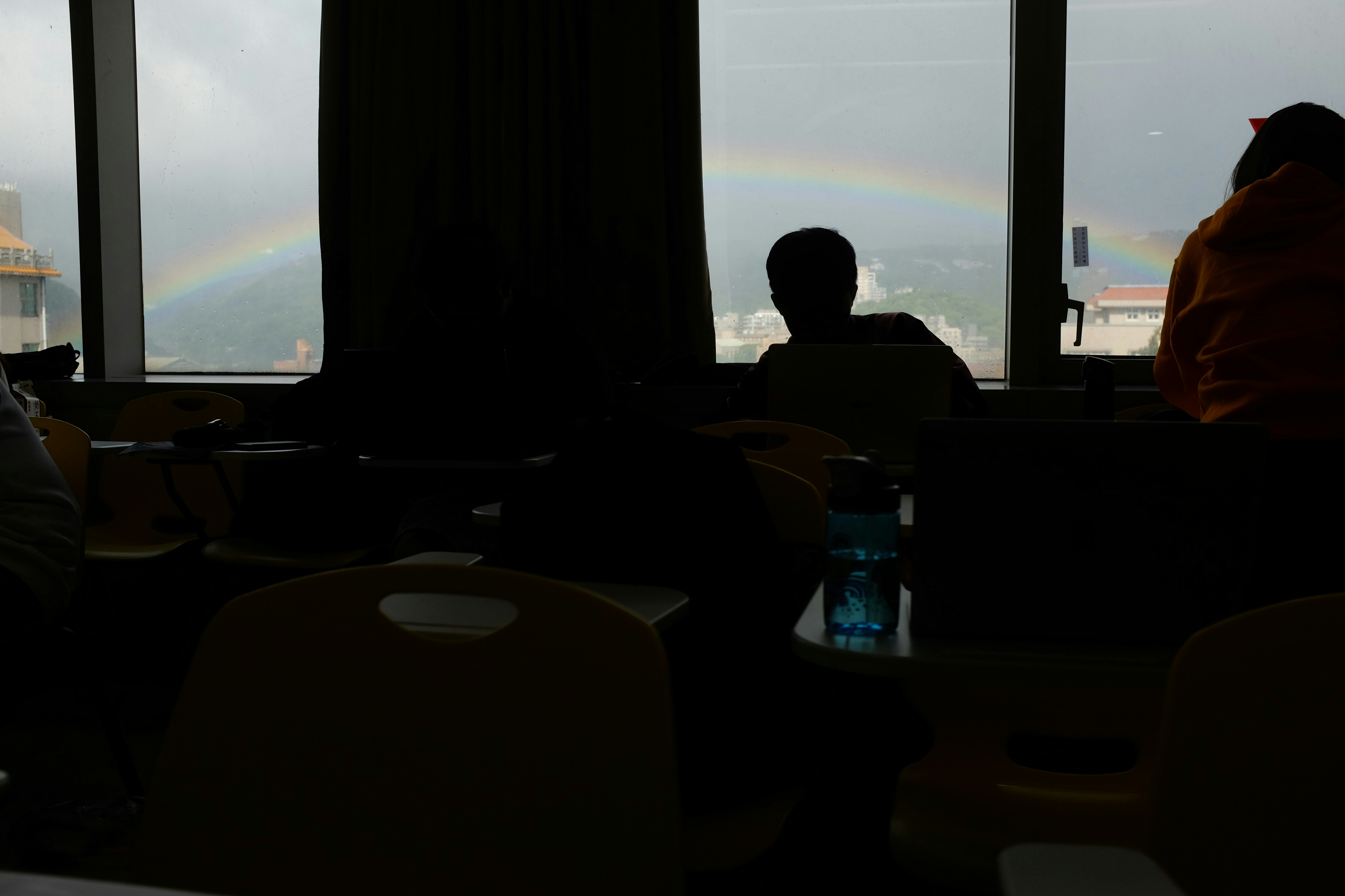 man sitting on chair near window
