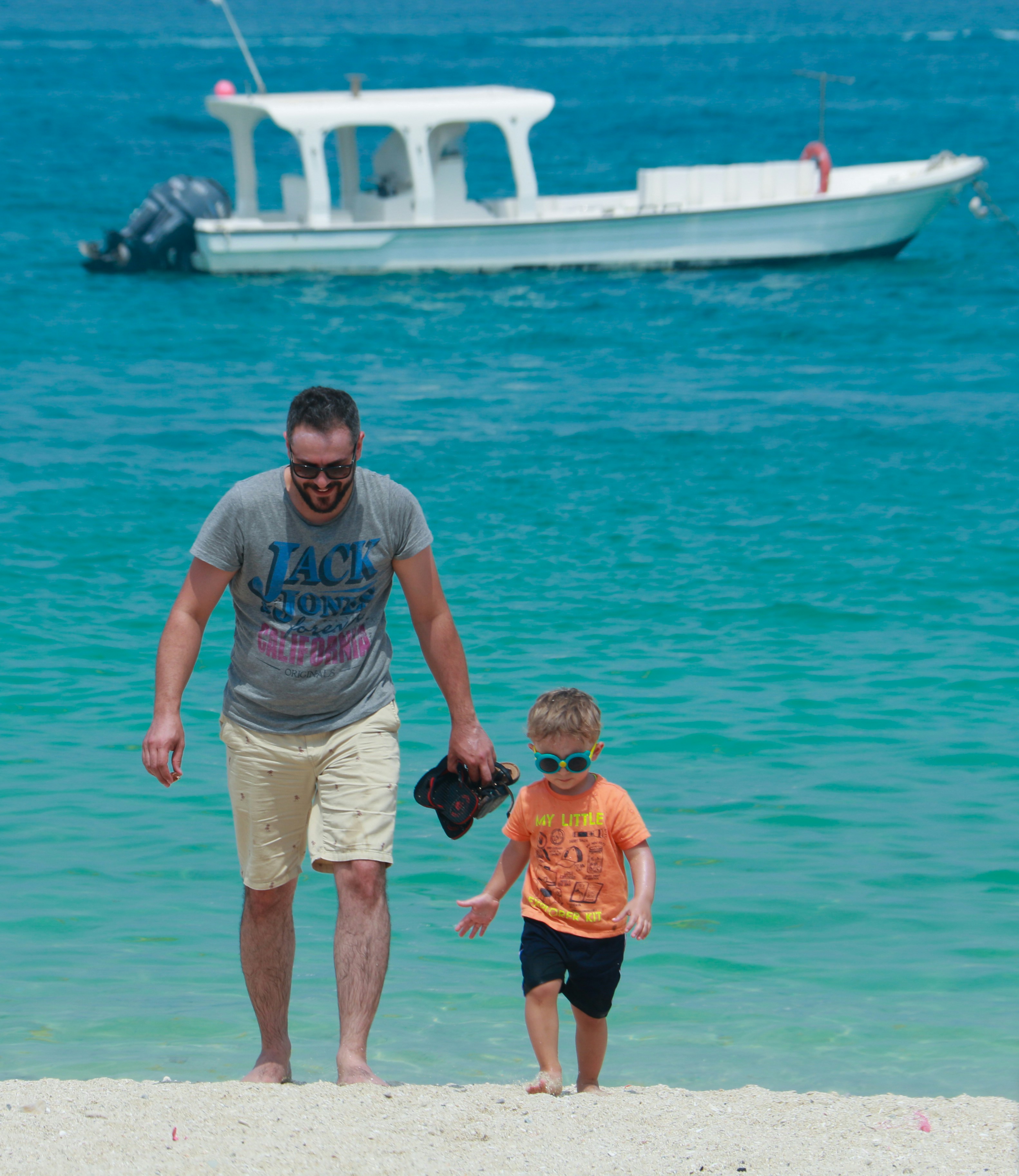 Father and Son Walk the Turquoise Shoreline