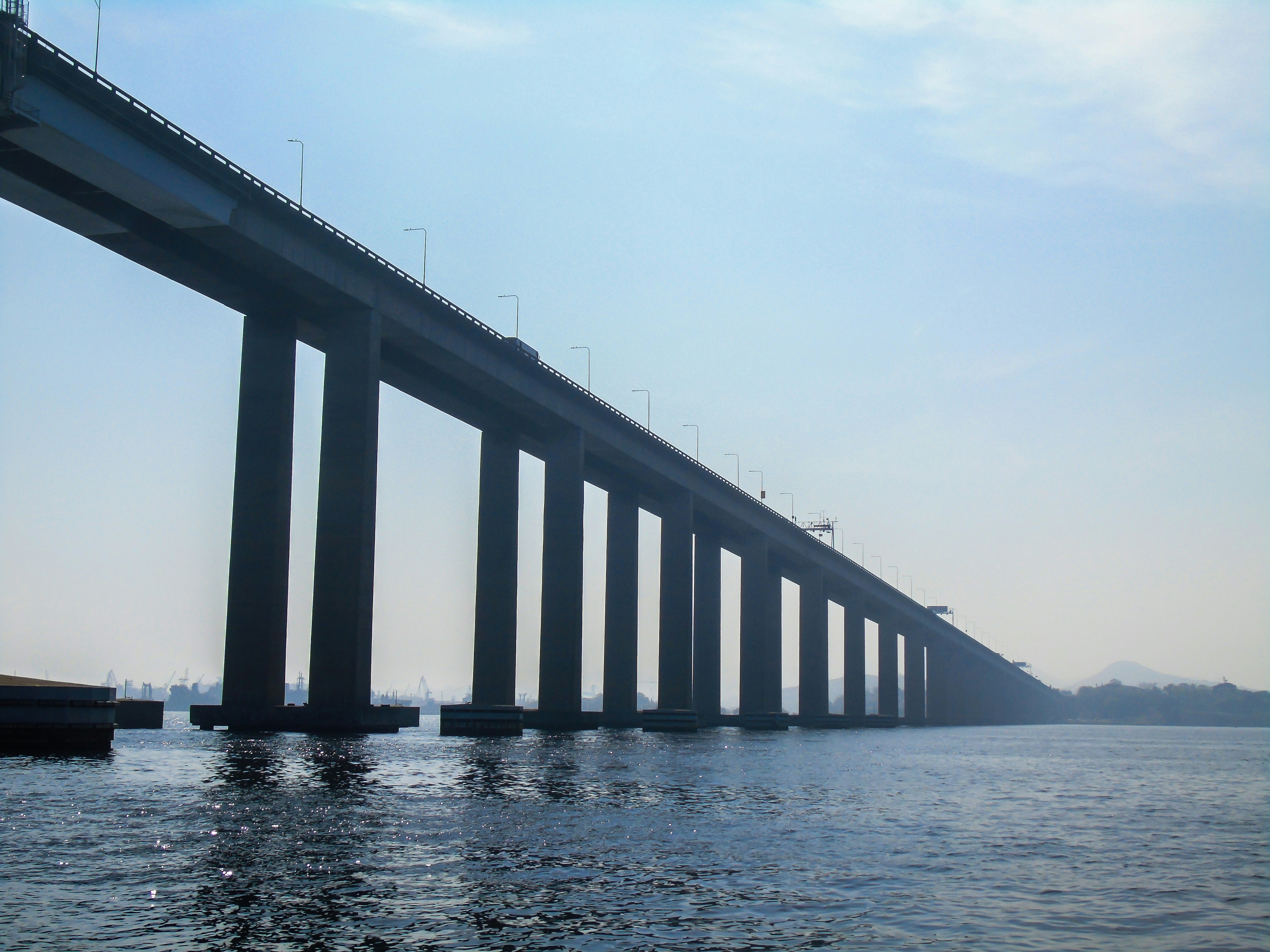 gray concrete bridge over body of water during daytime