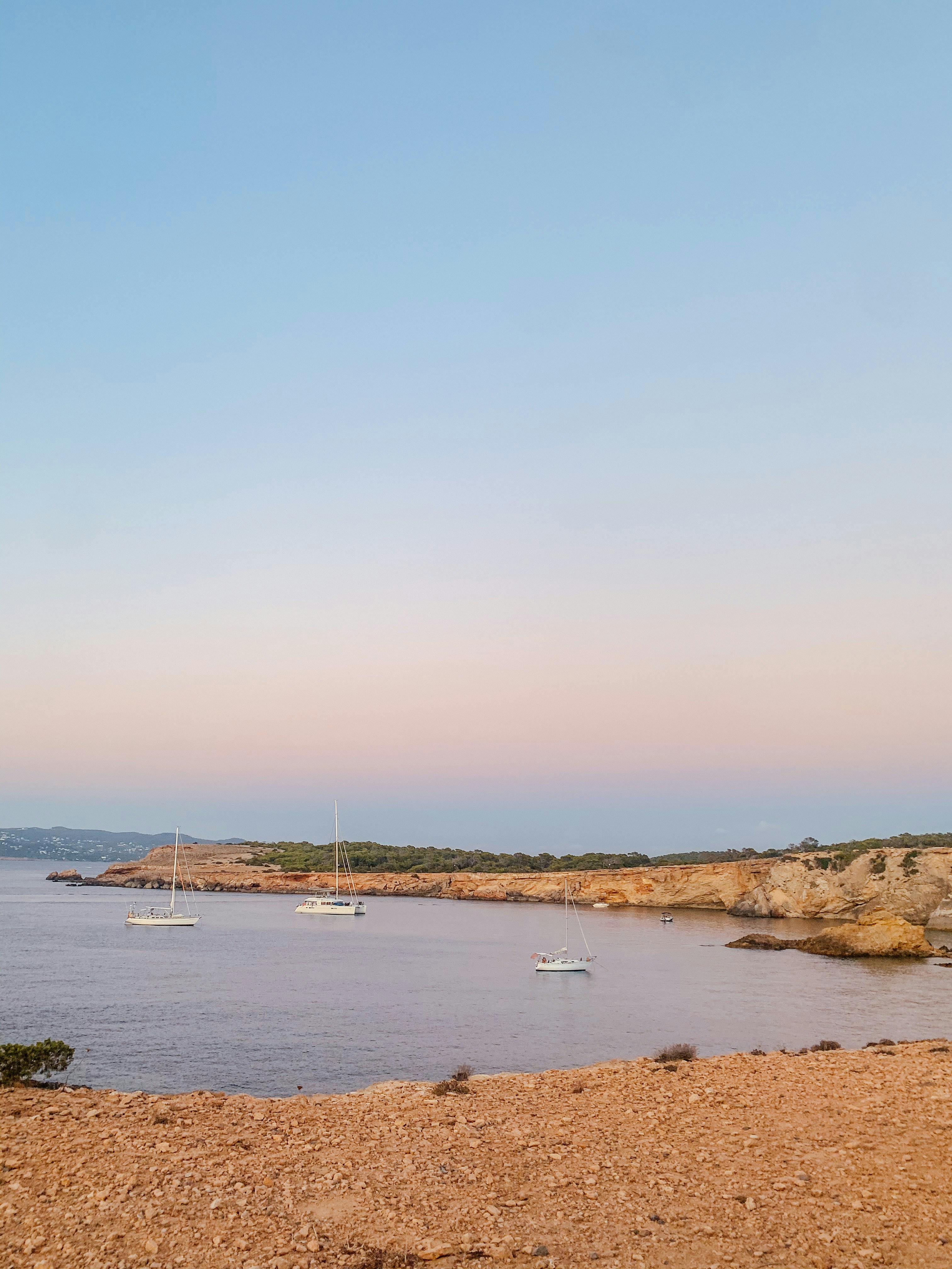 Dusk at the Cove: Sailboats Framing a Quiet Horizon