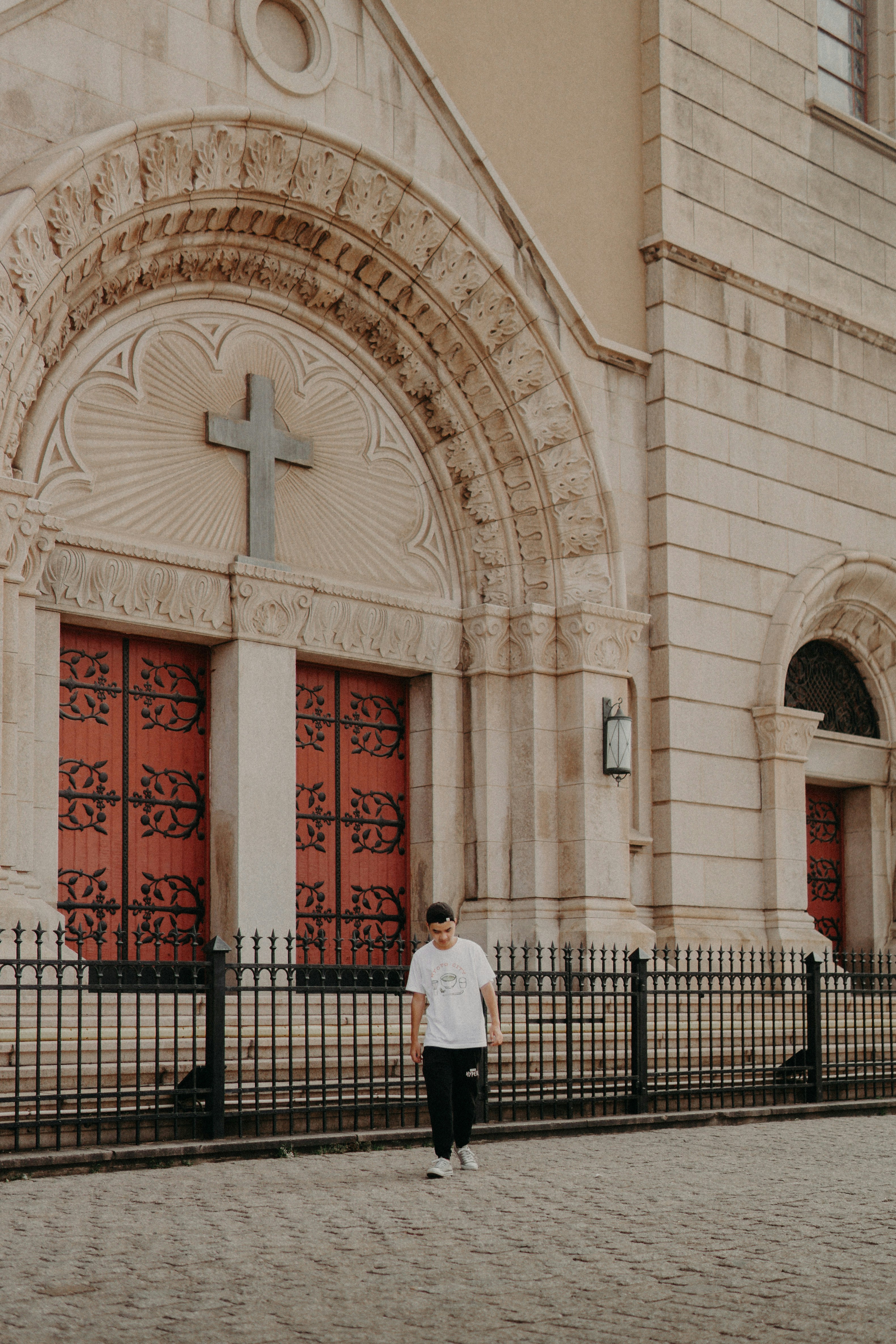 Youth at the Church Portal: Quiet Steps by the Red Doors