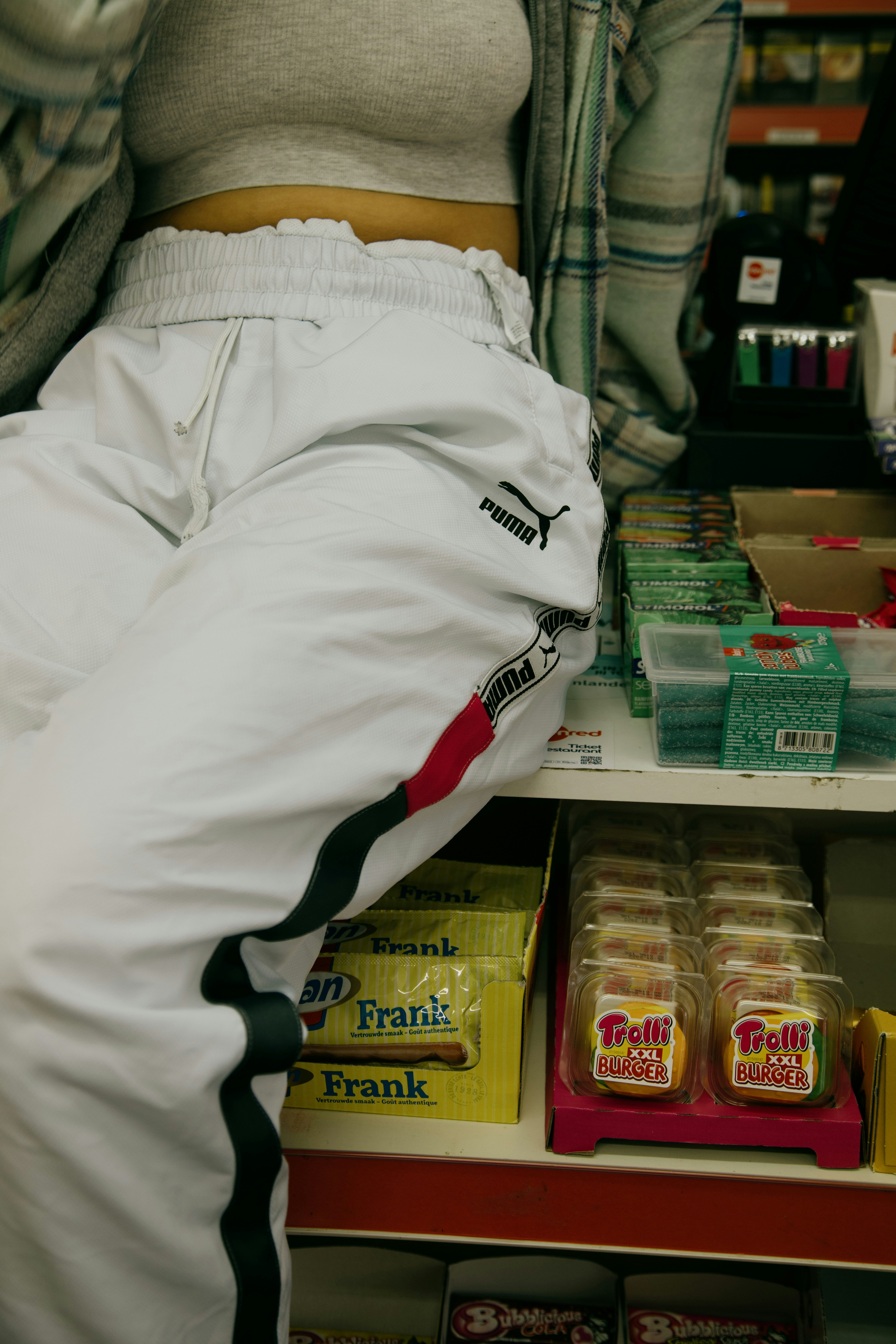Casual Store-Aisle Pose in White PUMA Trackpants