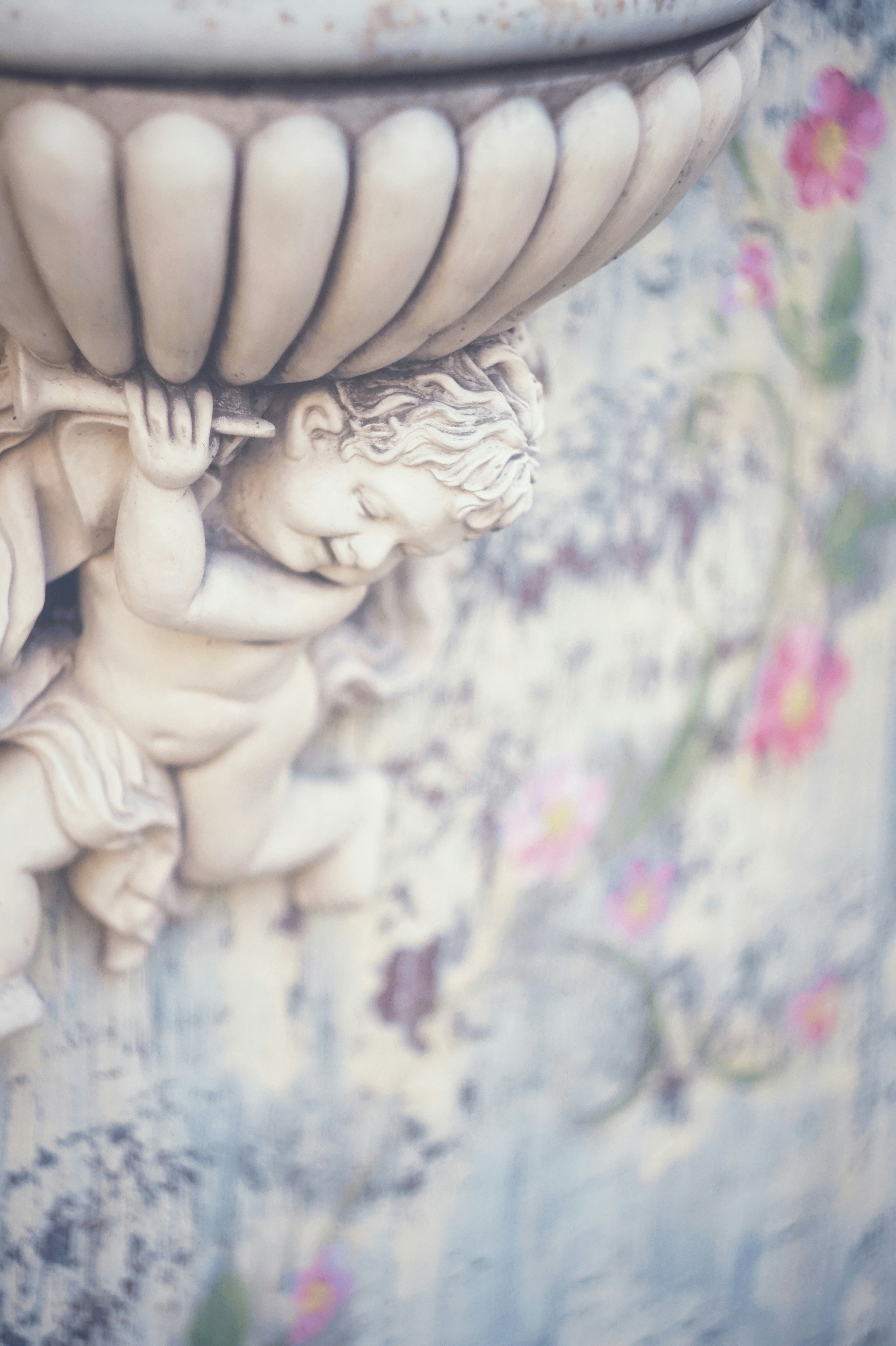 Stone Cherub Balancing on a Floral Fountain Edge