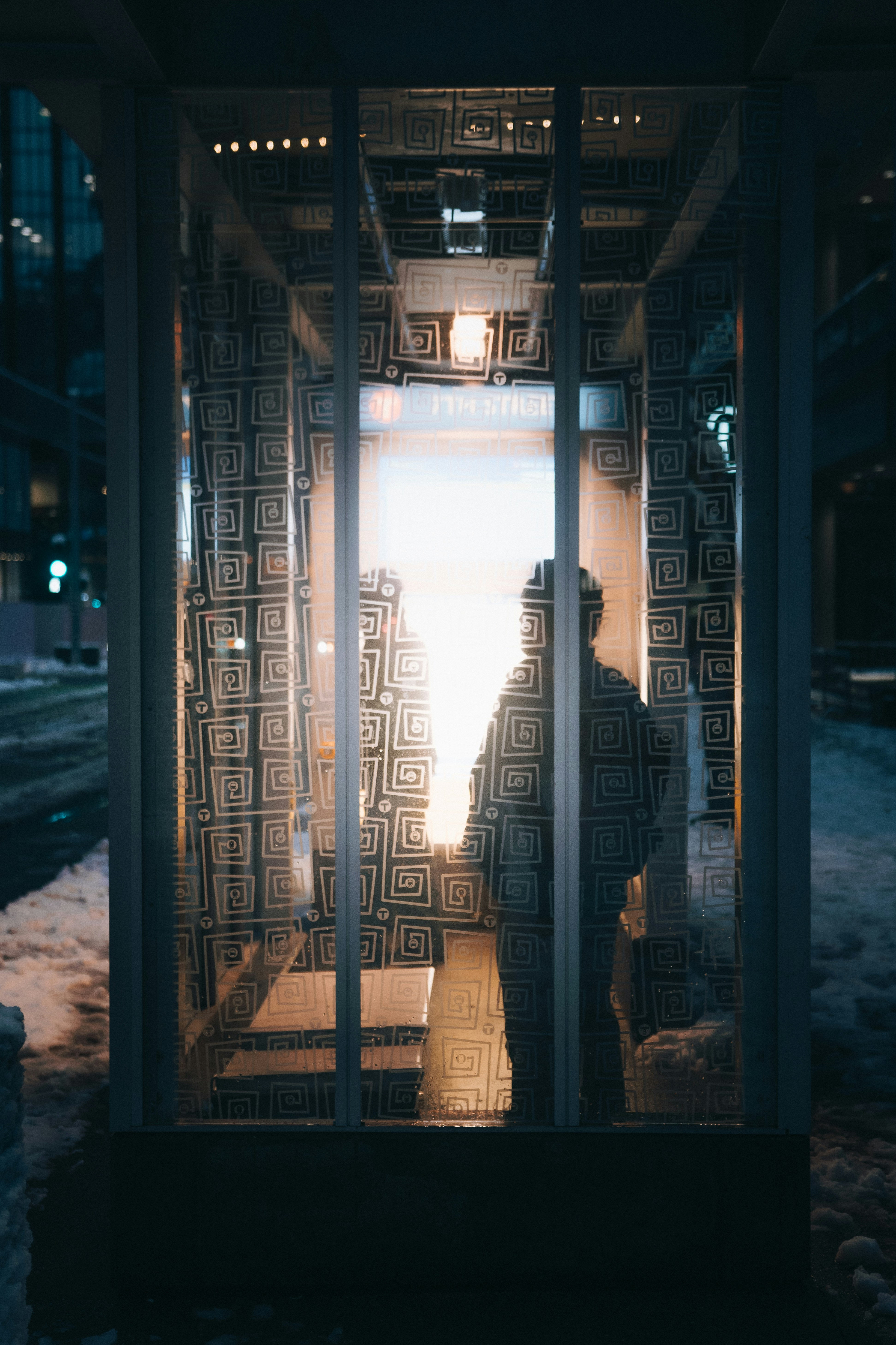 Patterned Glass Booth: Night Silhouette in a Warm Glow