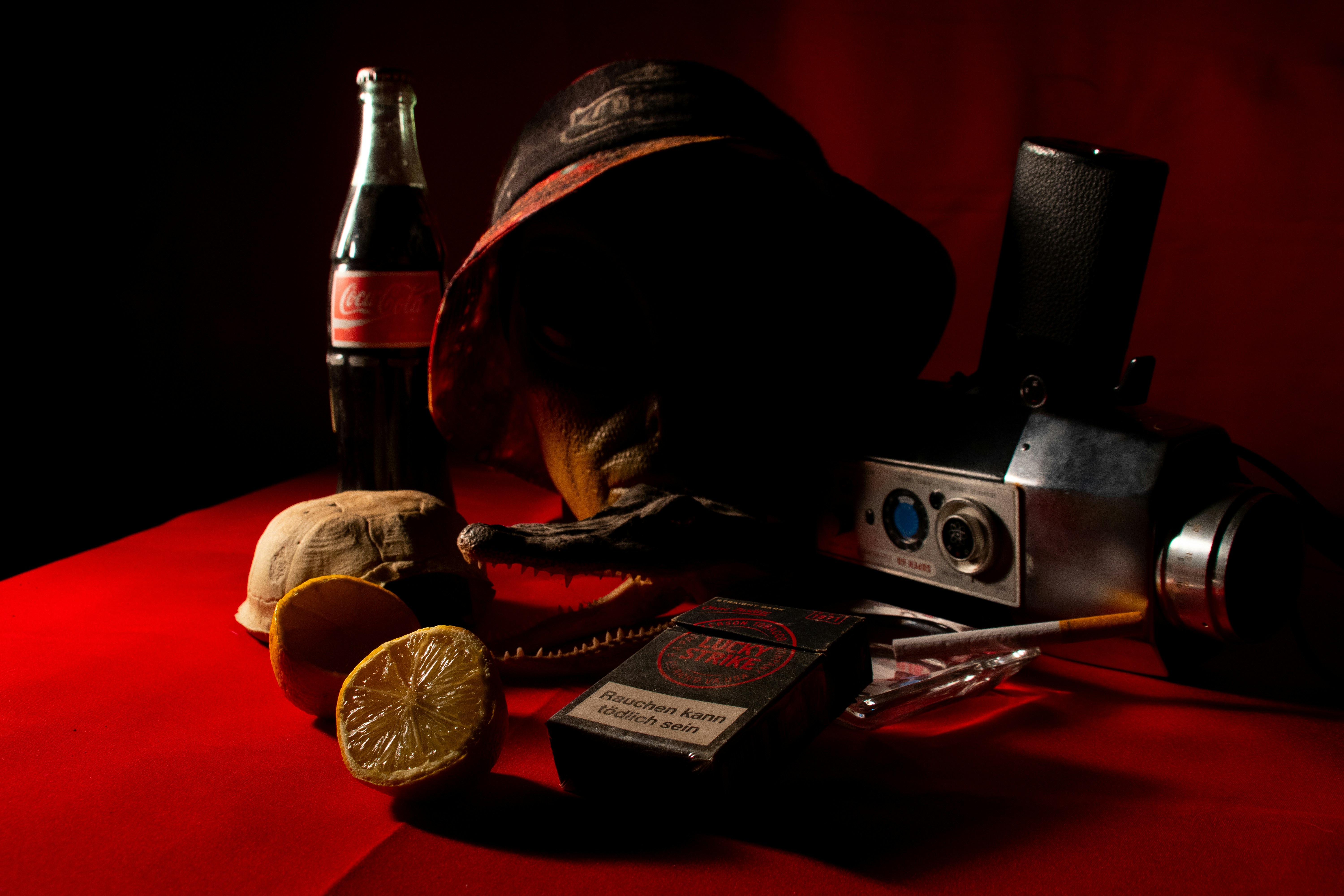 Crimson Velvet Stilllife: Halved Lemon, Cola, and a Retro Film Rig