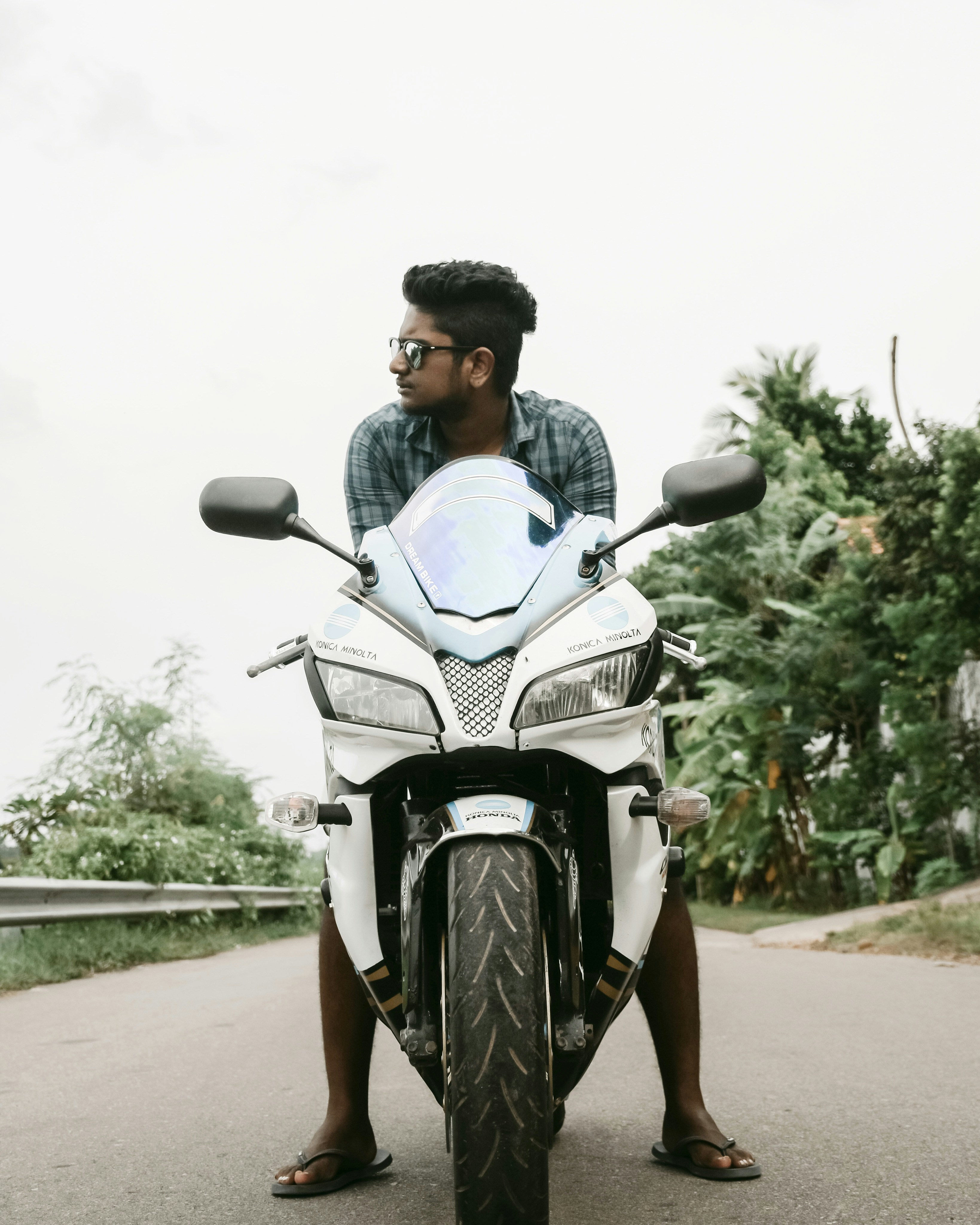 Motorcycle Rendezvous: A Quiet Moment with a Rider on an Urban Crest