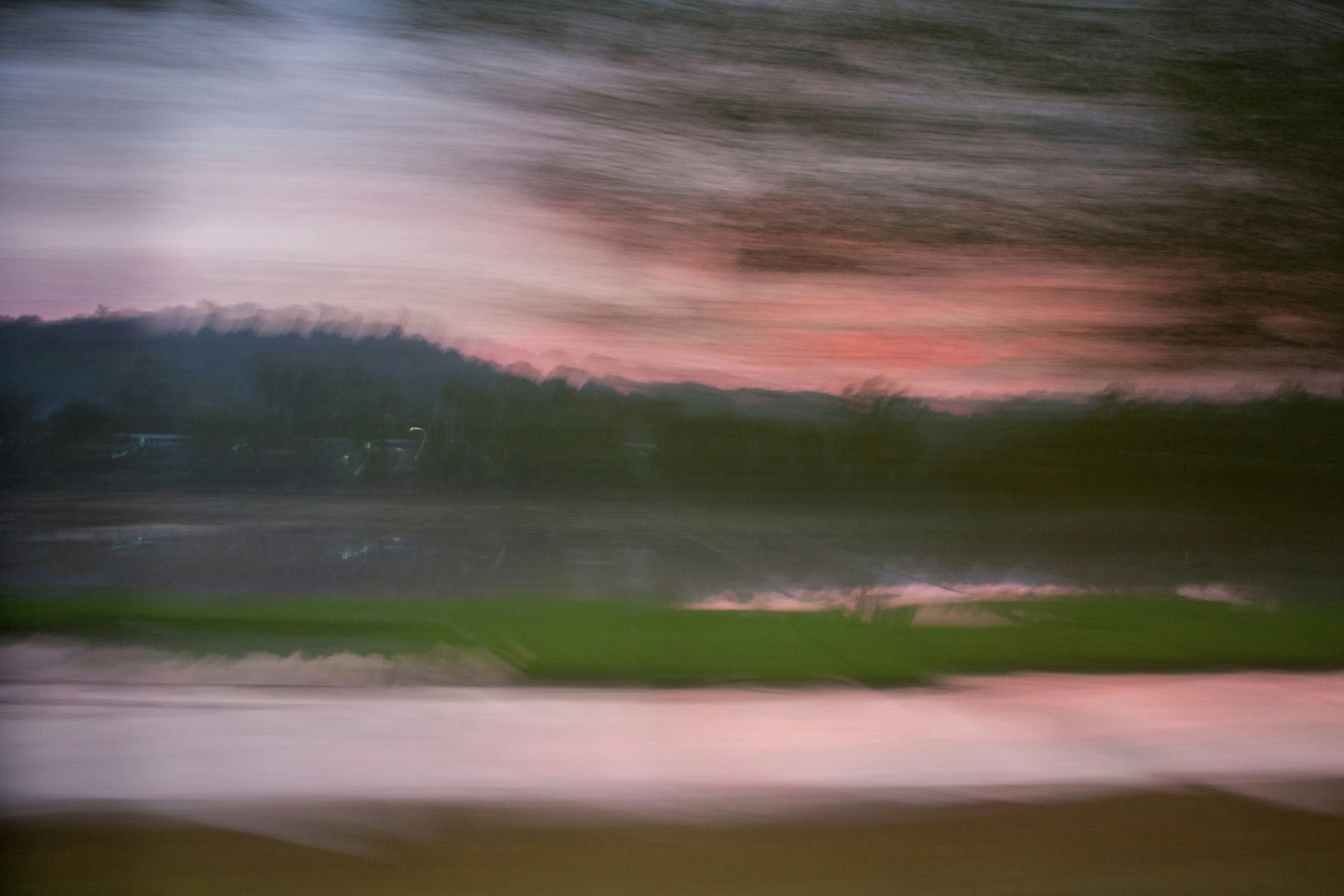 Blush of Dusk Over a Blurred Riverbank
