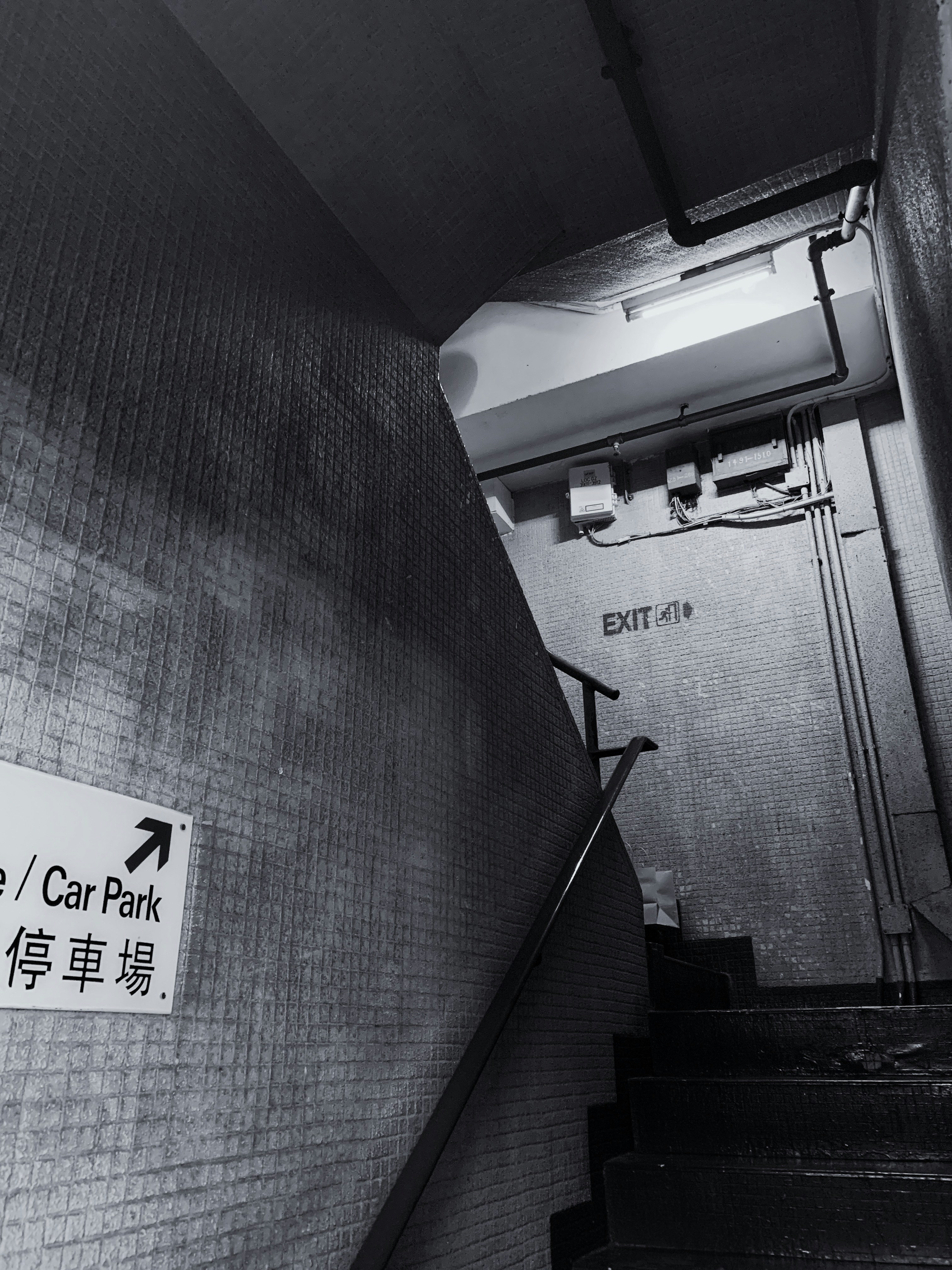 Stairwell Exit: Concrete Angles and Narrow Light