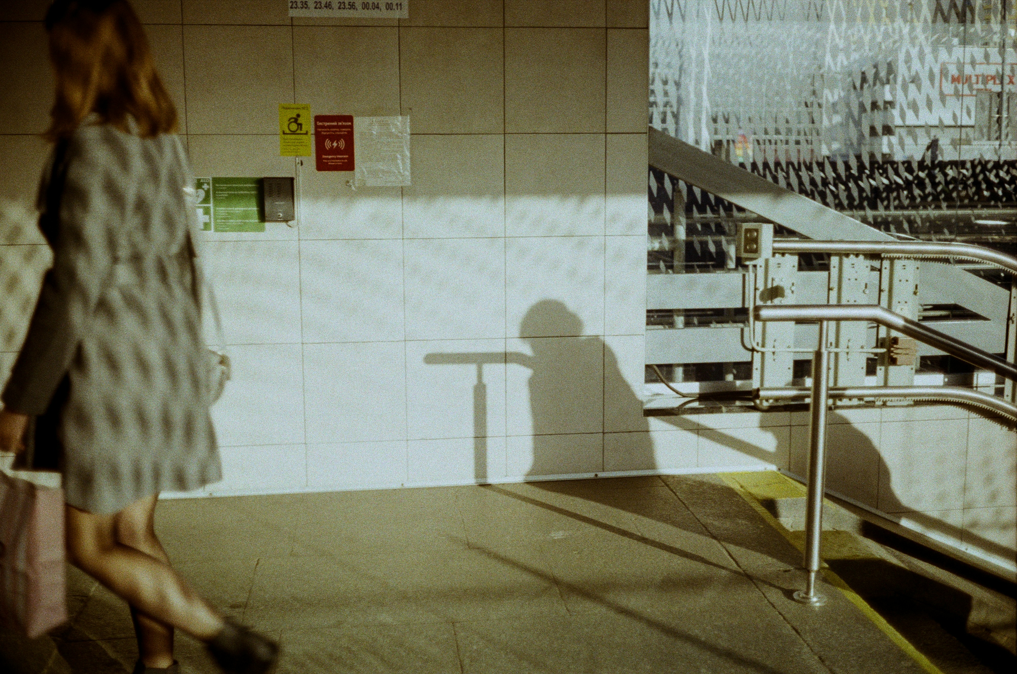 white metal shelf near white tiled wall