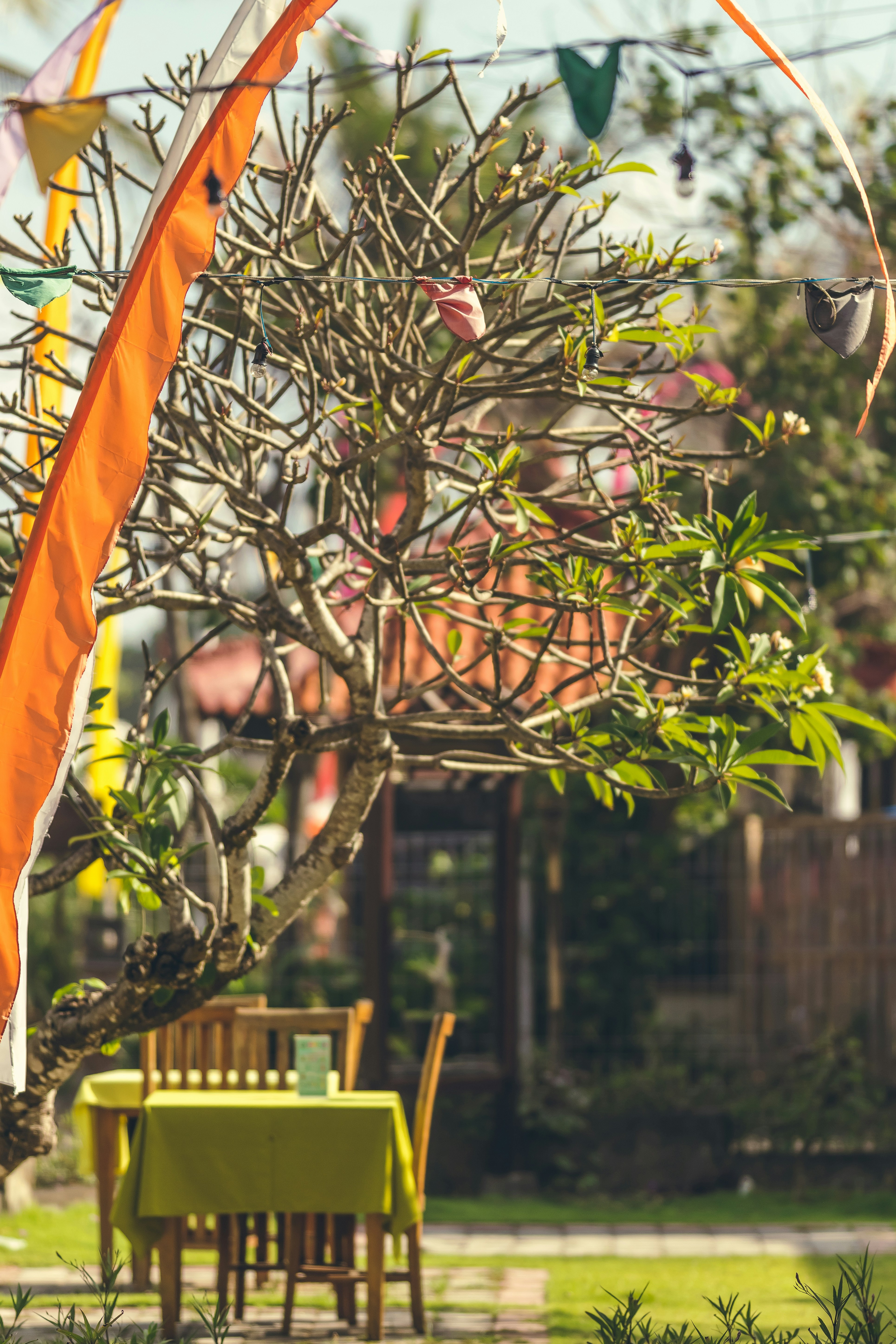 Prayer Flags and Patio Table in a Sunlit Garden