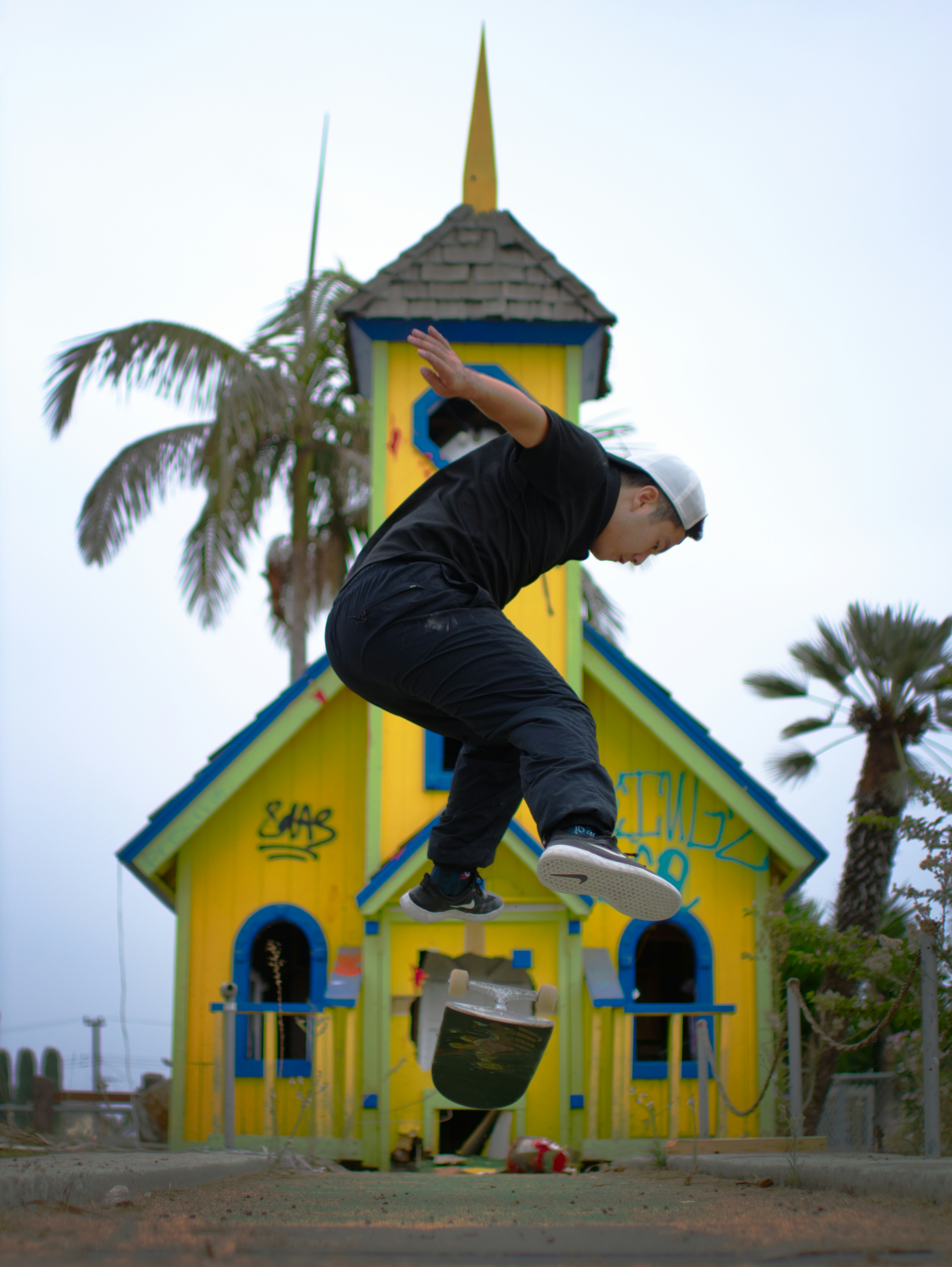 Midair Kick Over a Sunny Beach Chapel