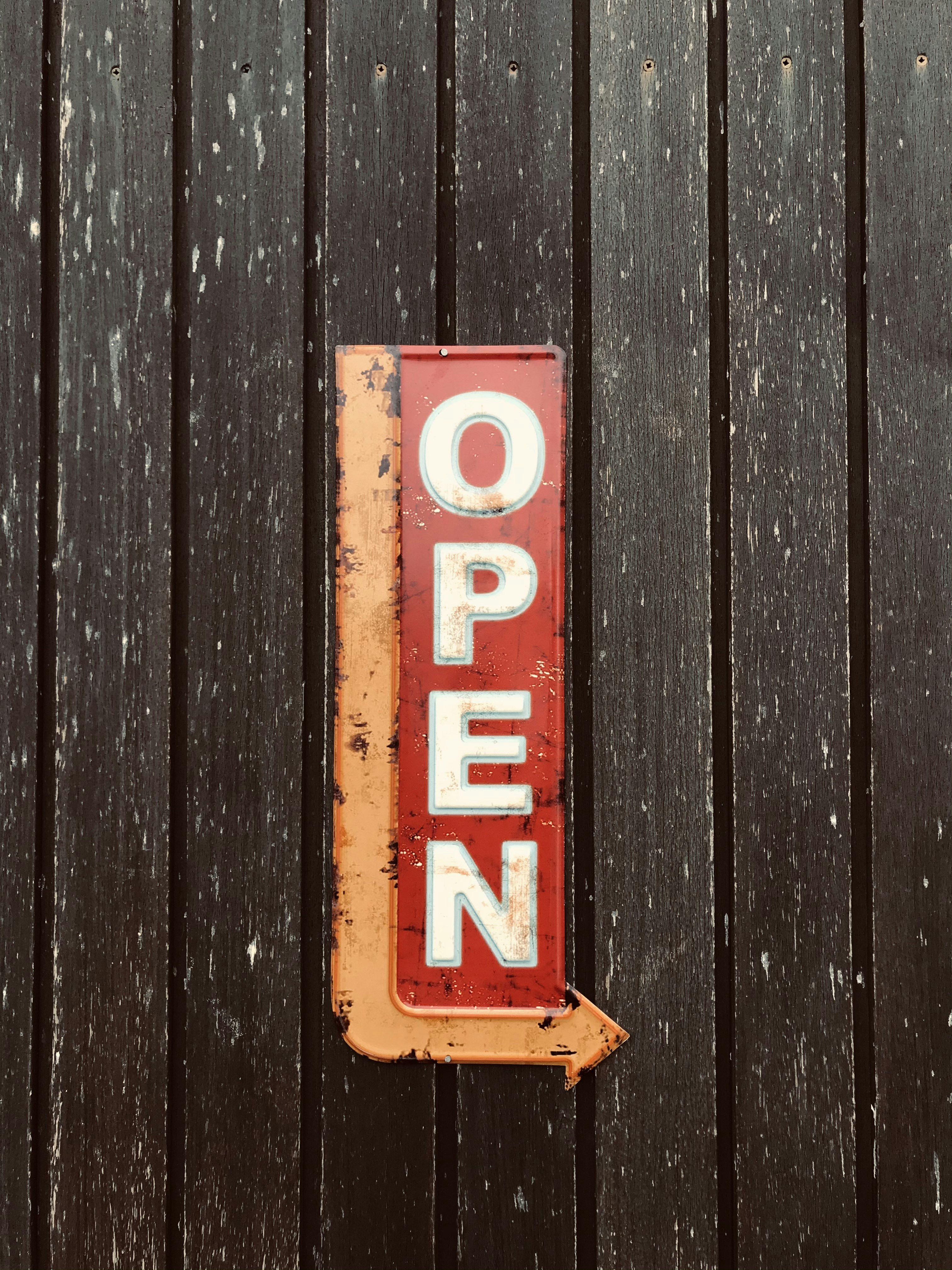 Open Sign on a Weathered Door