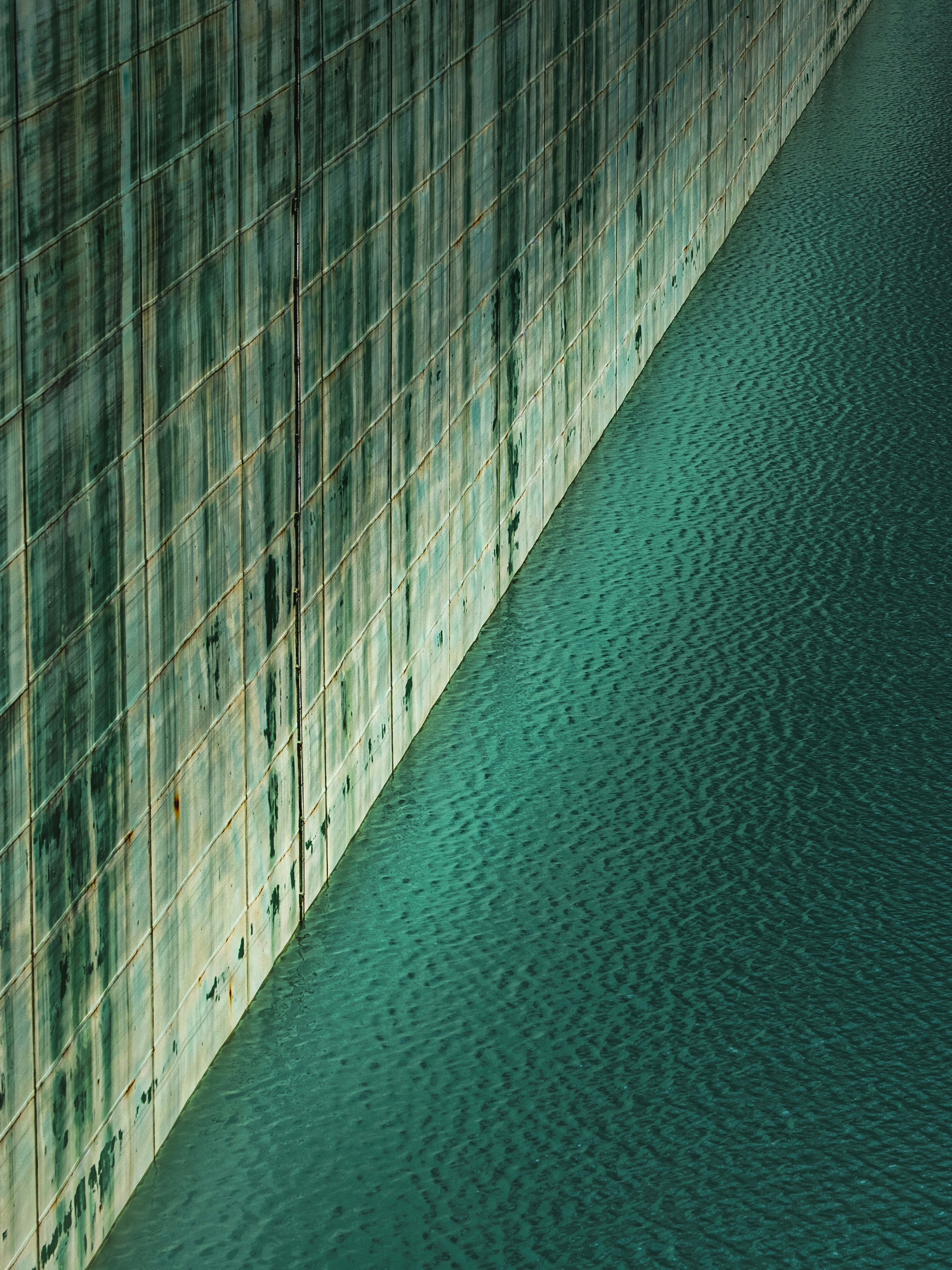Turquoise Boundary: The Diagonal Where Water Meets Weathered Concrete