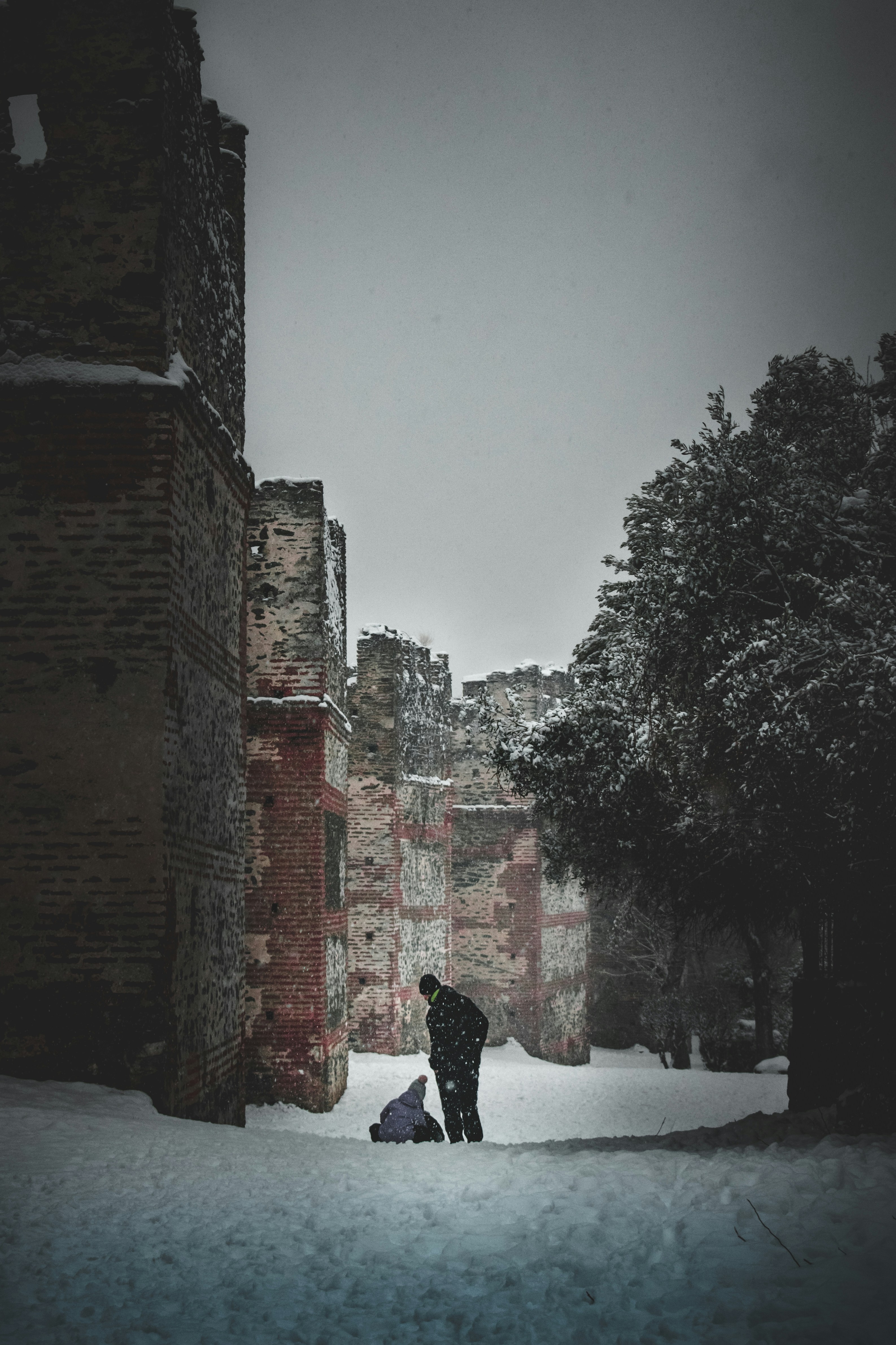 Footprints of Silence: A Winter Moment Between Ruins