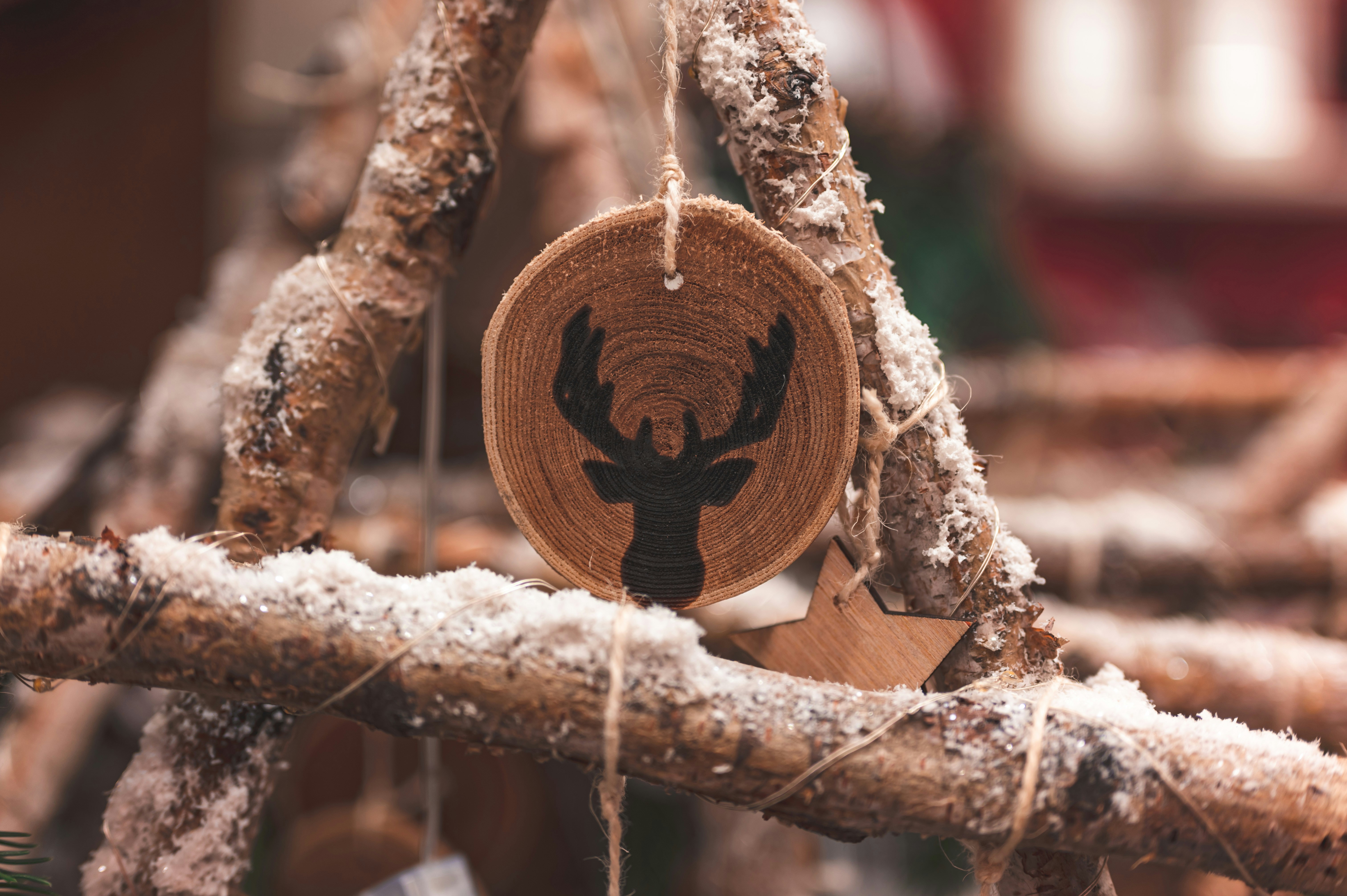 Deer Silhouette Adorned on a Snow-Kissed Wood Ornament