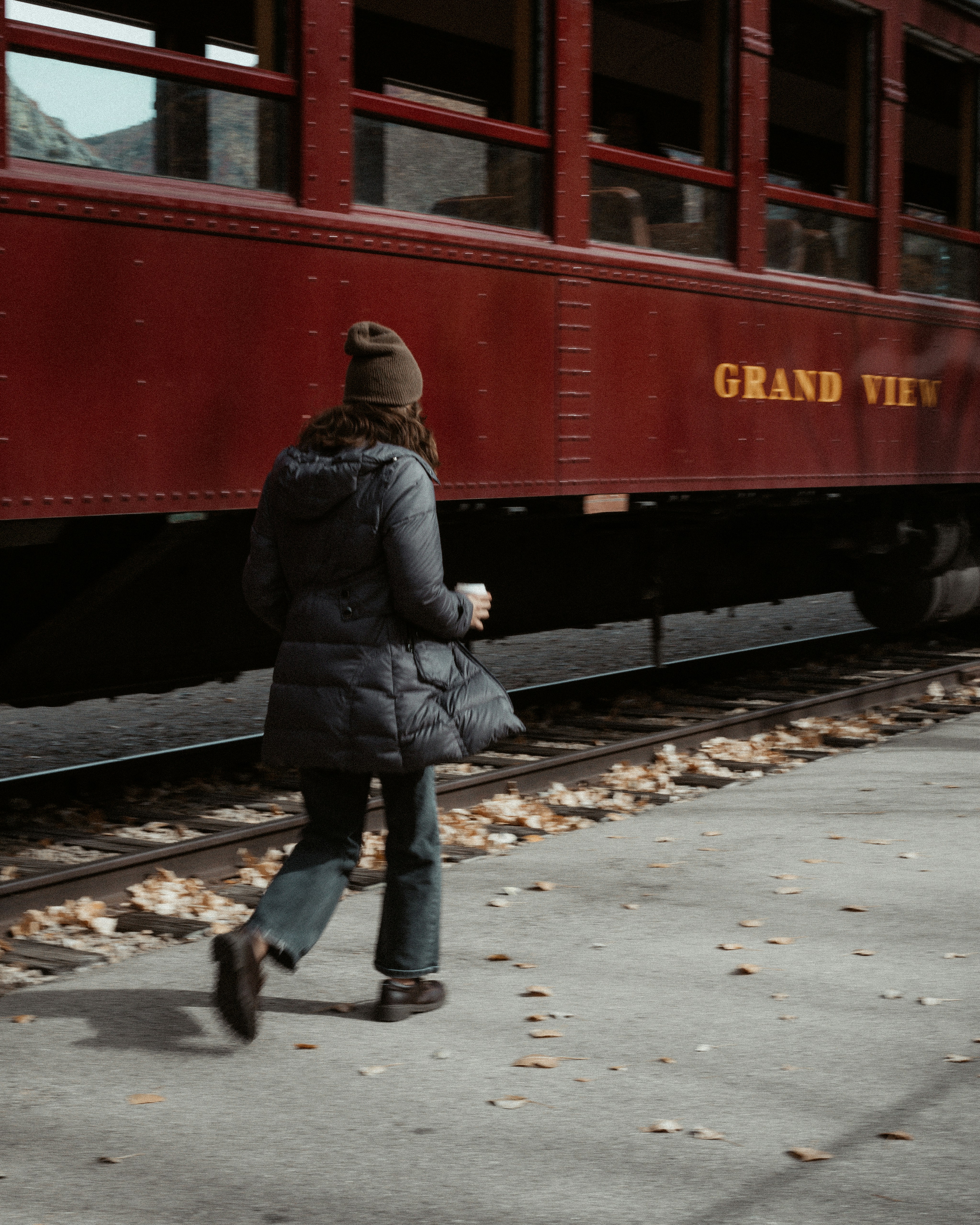 Traveler in a Winter Coat Approaches the Grand View Car
