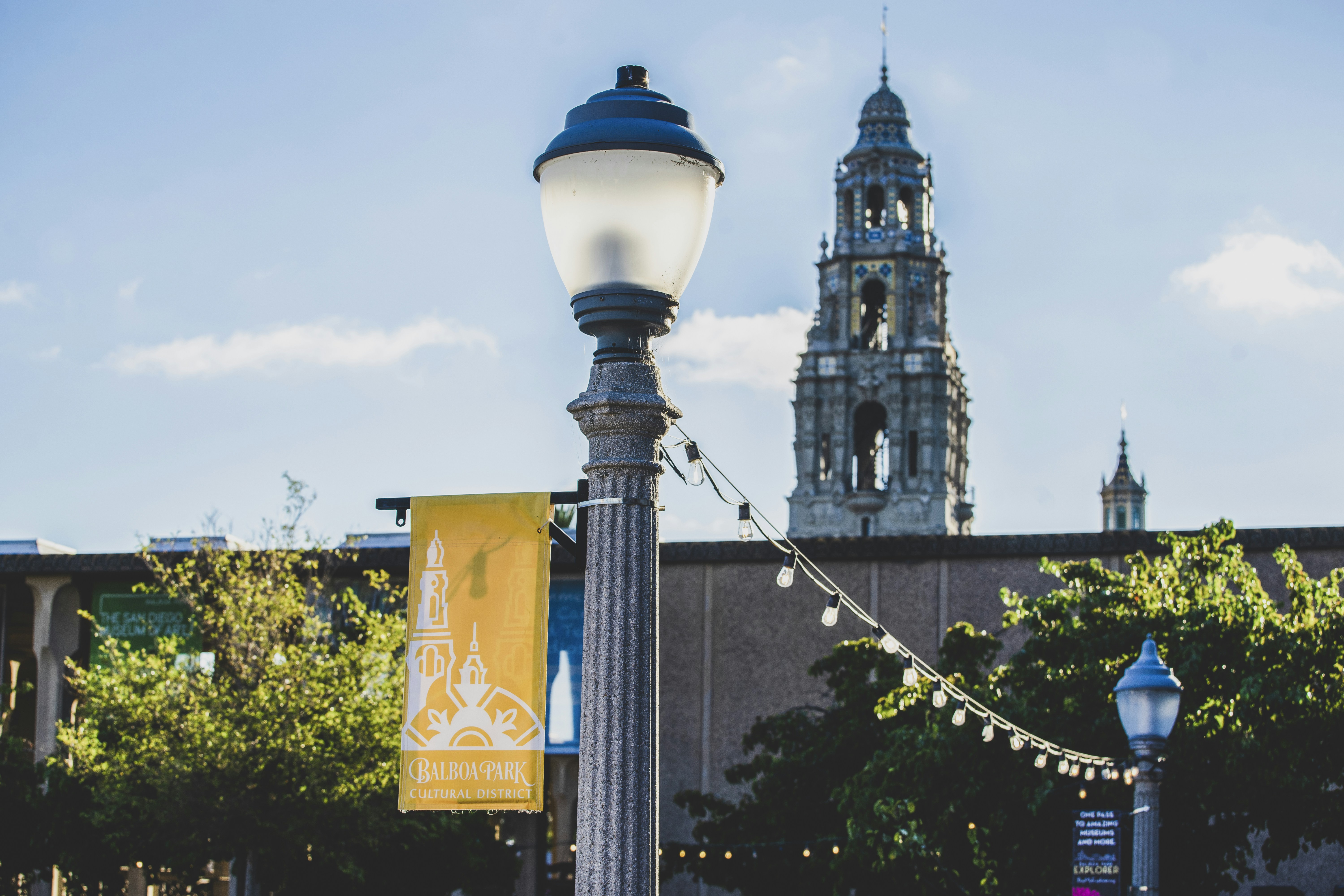 Lantern Glimmer Over City Hall: A Bannered Street Scene