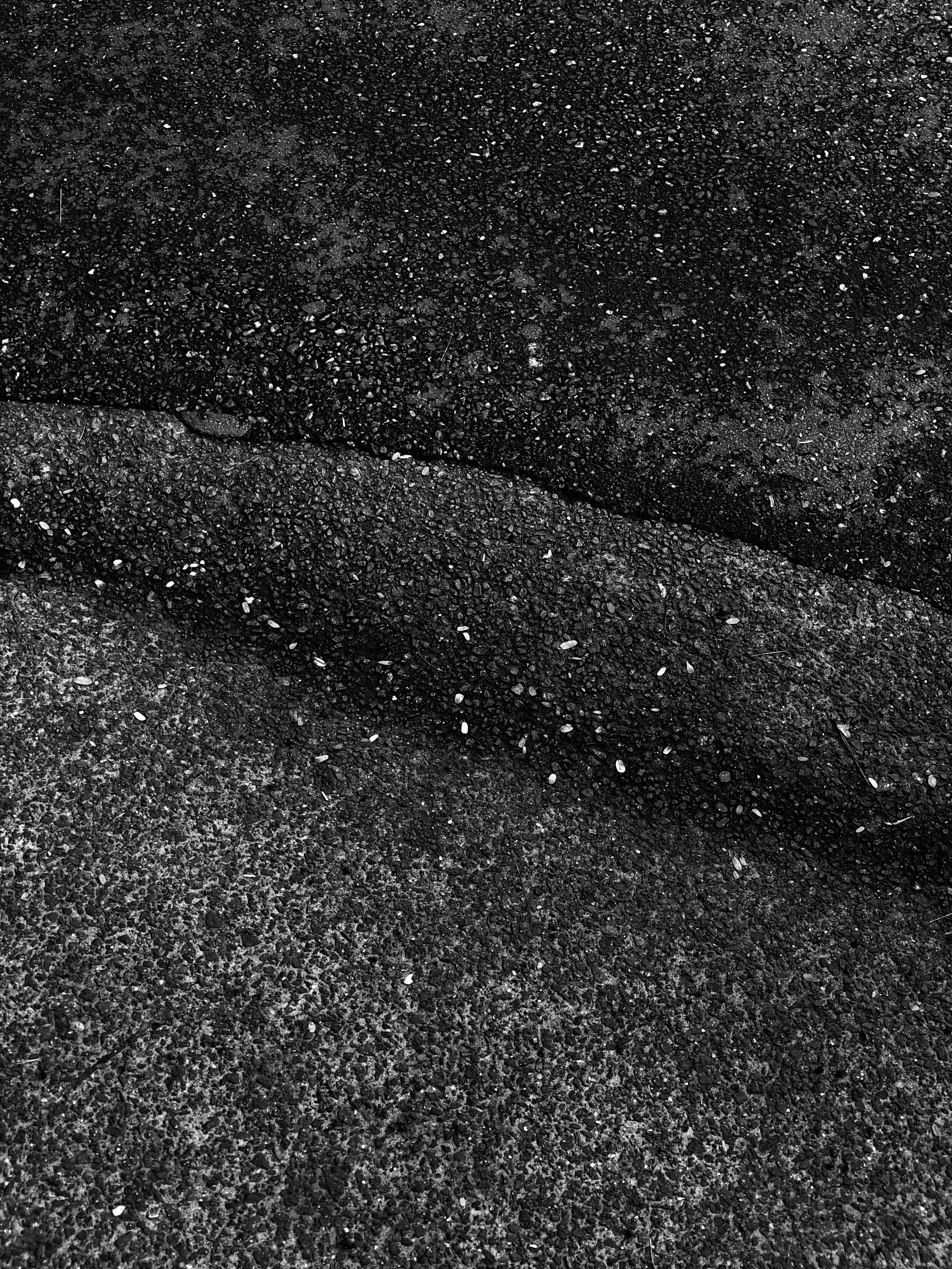 Abstract black and white composition showcasing textured surfaces and subtle variations in light and shadow.