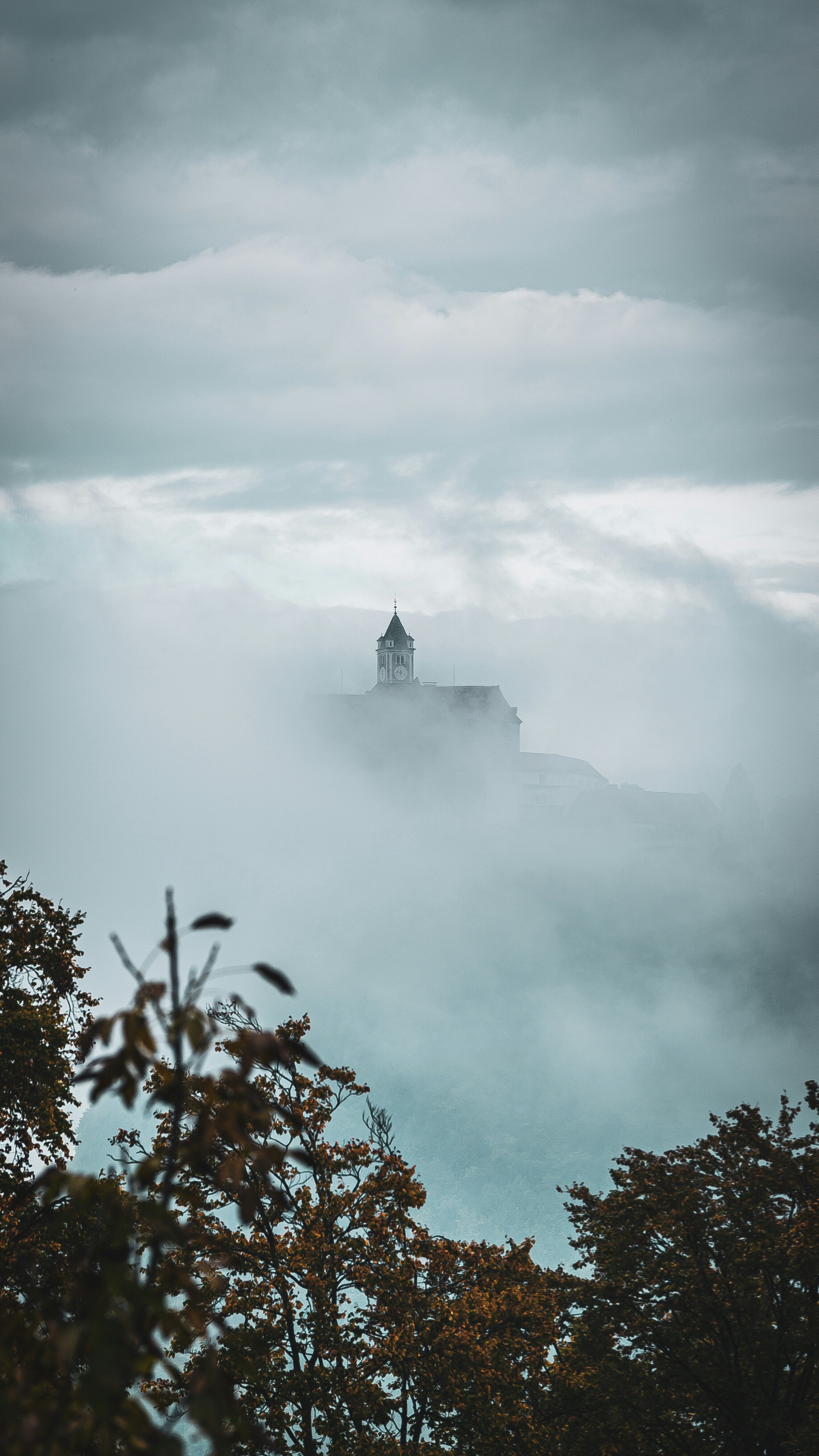 Mistbound Citadel: The Clock Tower Rises Through a Sea of Fog