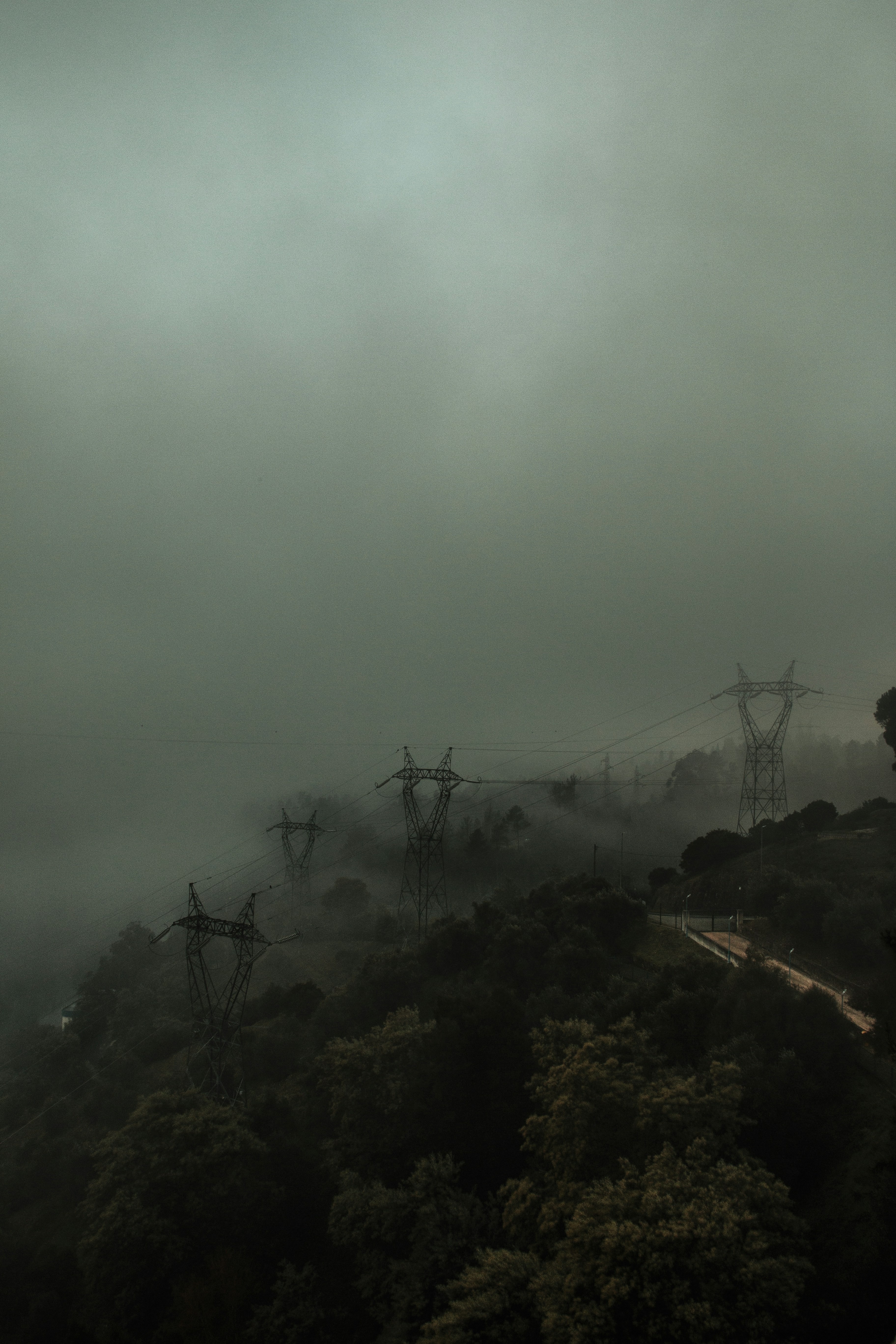 Misty Crest: Transmission Towers Thread a Quiet Ridge