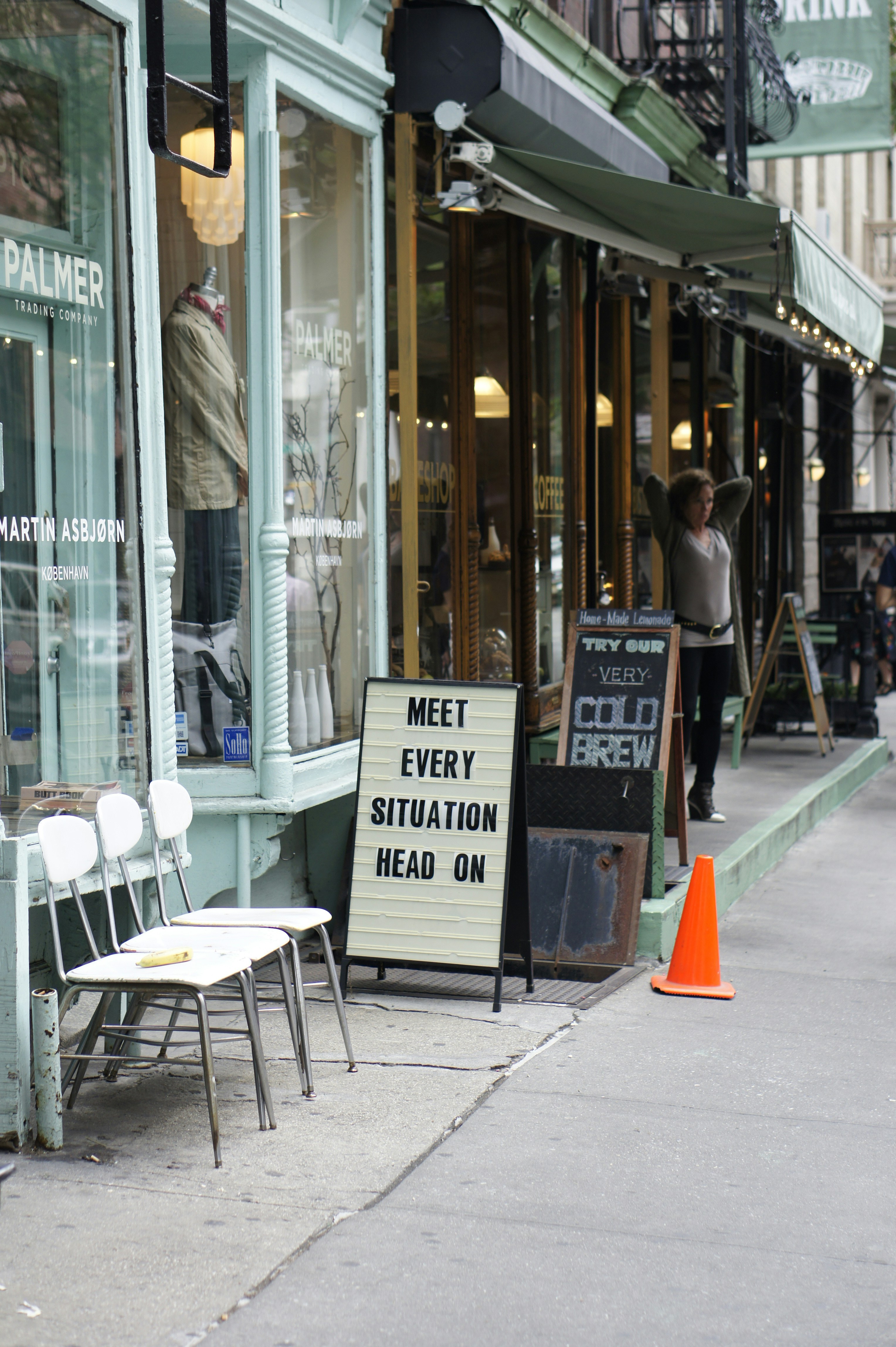 Signboard Street Pulse: A Quiet Moment Outside a Café