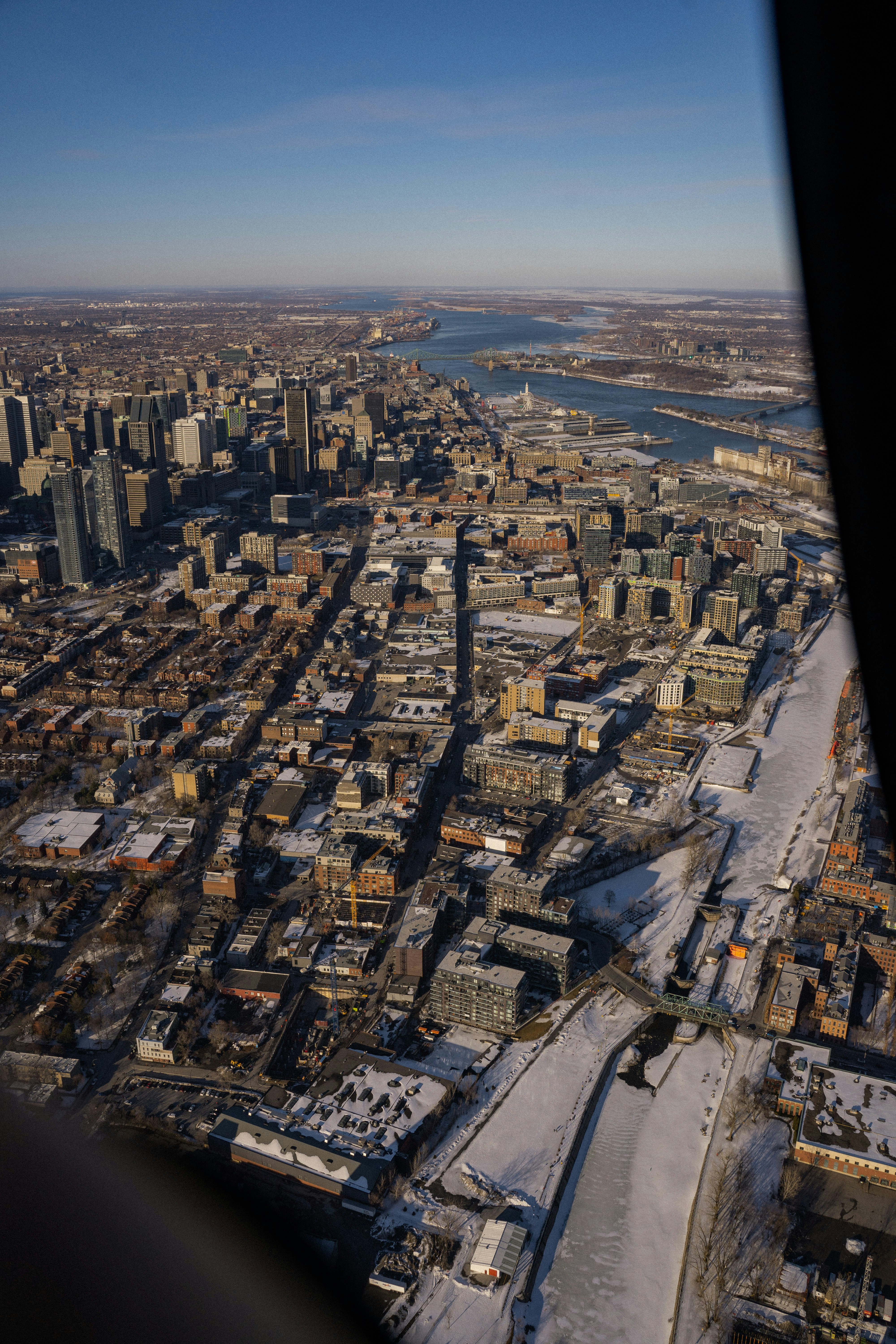 Icy Dawn Over a Winding River: Winter Cityscape from Above
