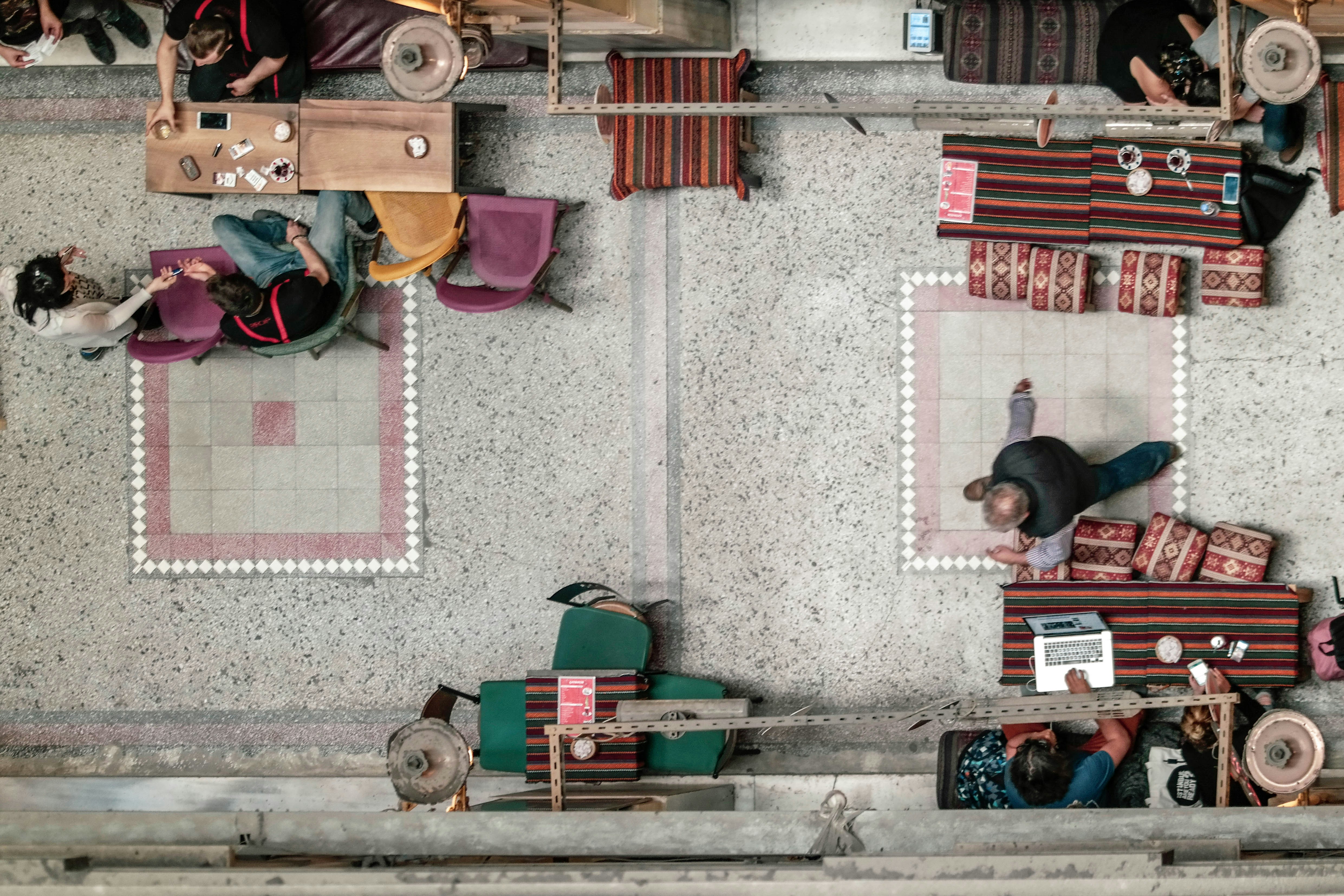 Aerial Market Calm: Rugs, Looms, and Footsteps on a Sunlit Terrace