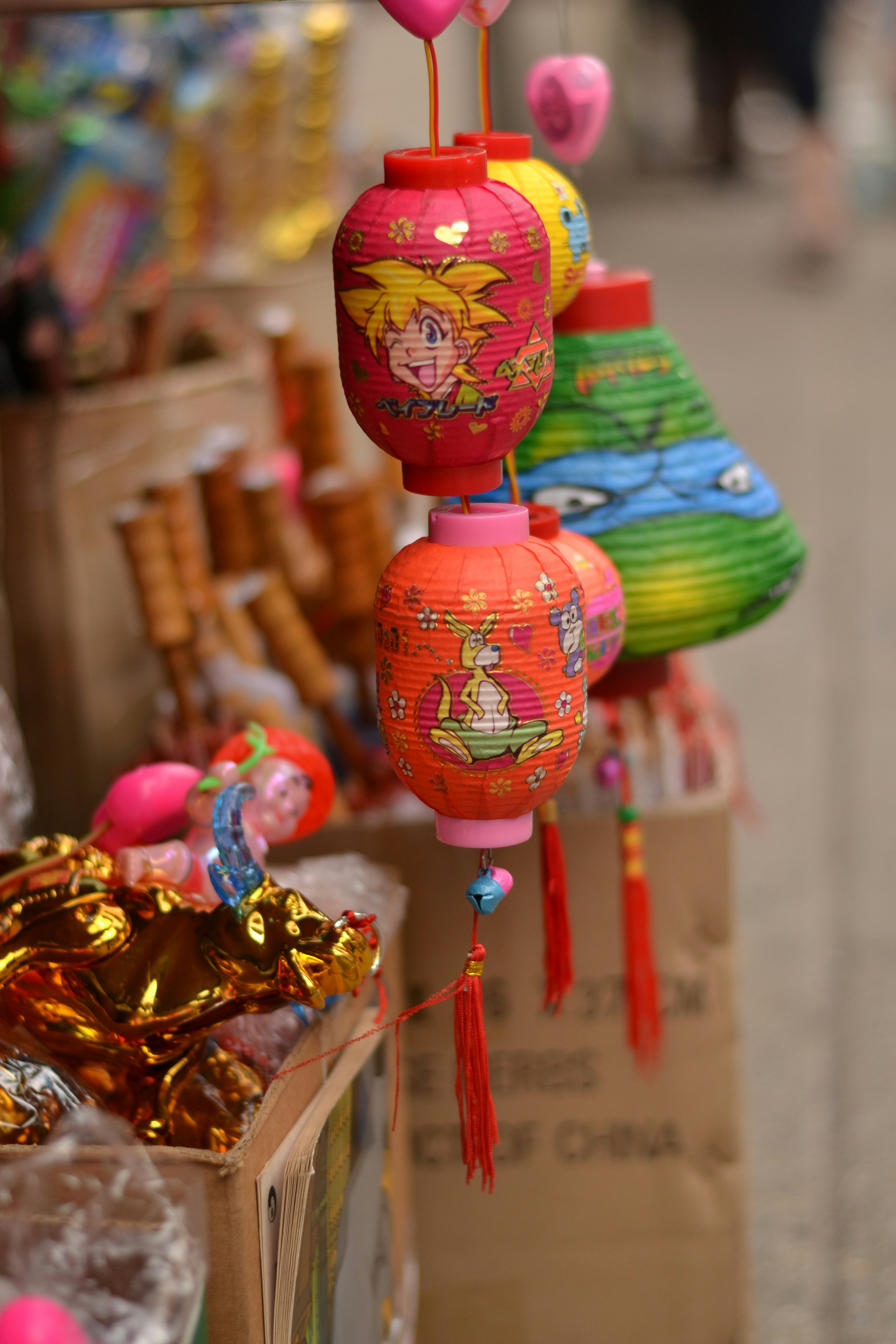 Lanterns in a Market Parade: A Burst of Color Against a Soft Street Blur